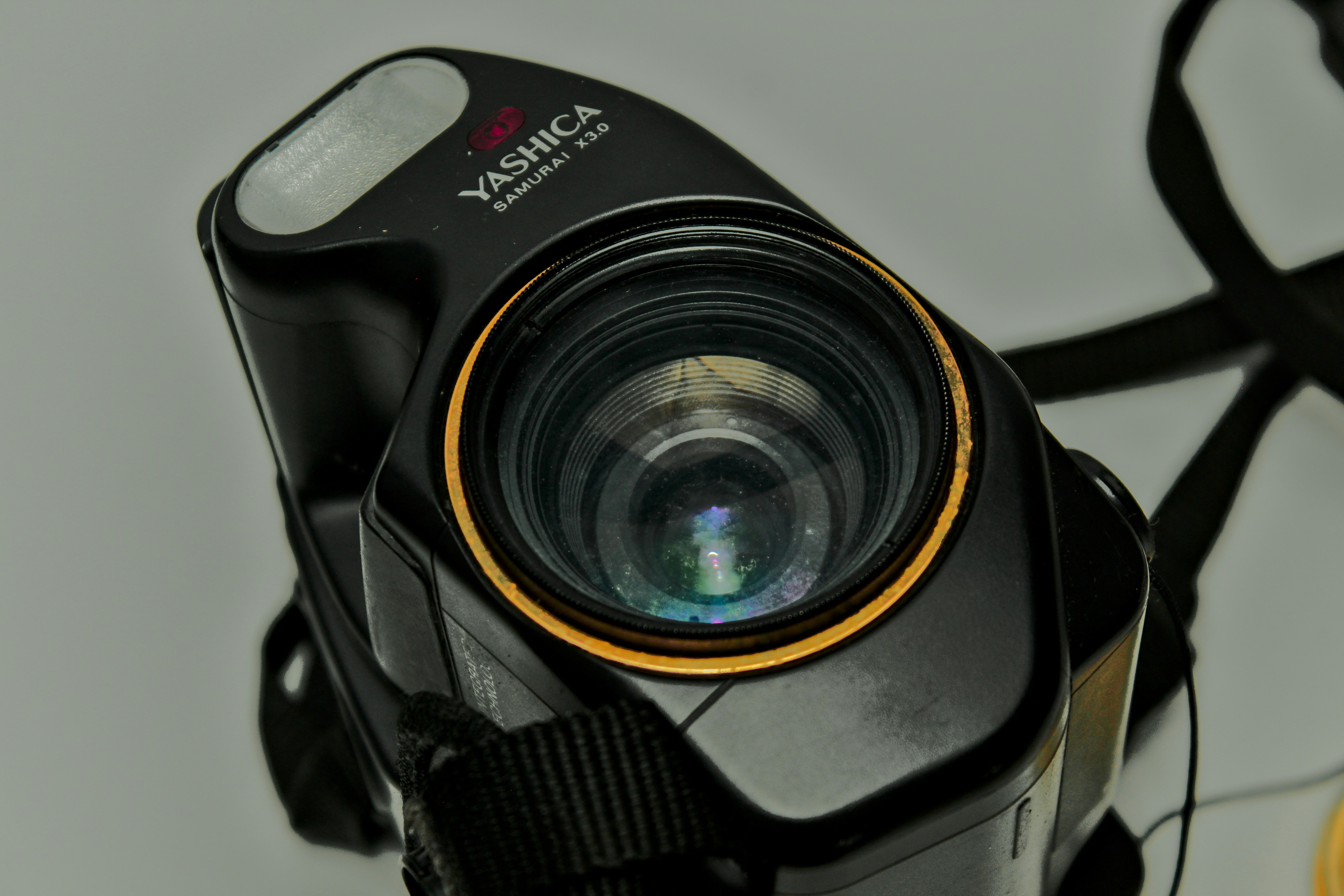 Close-up of a Yasinca/Analog Camcorder-style Lens with Orange Ring