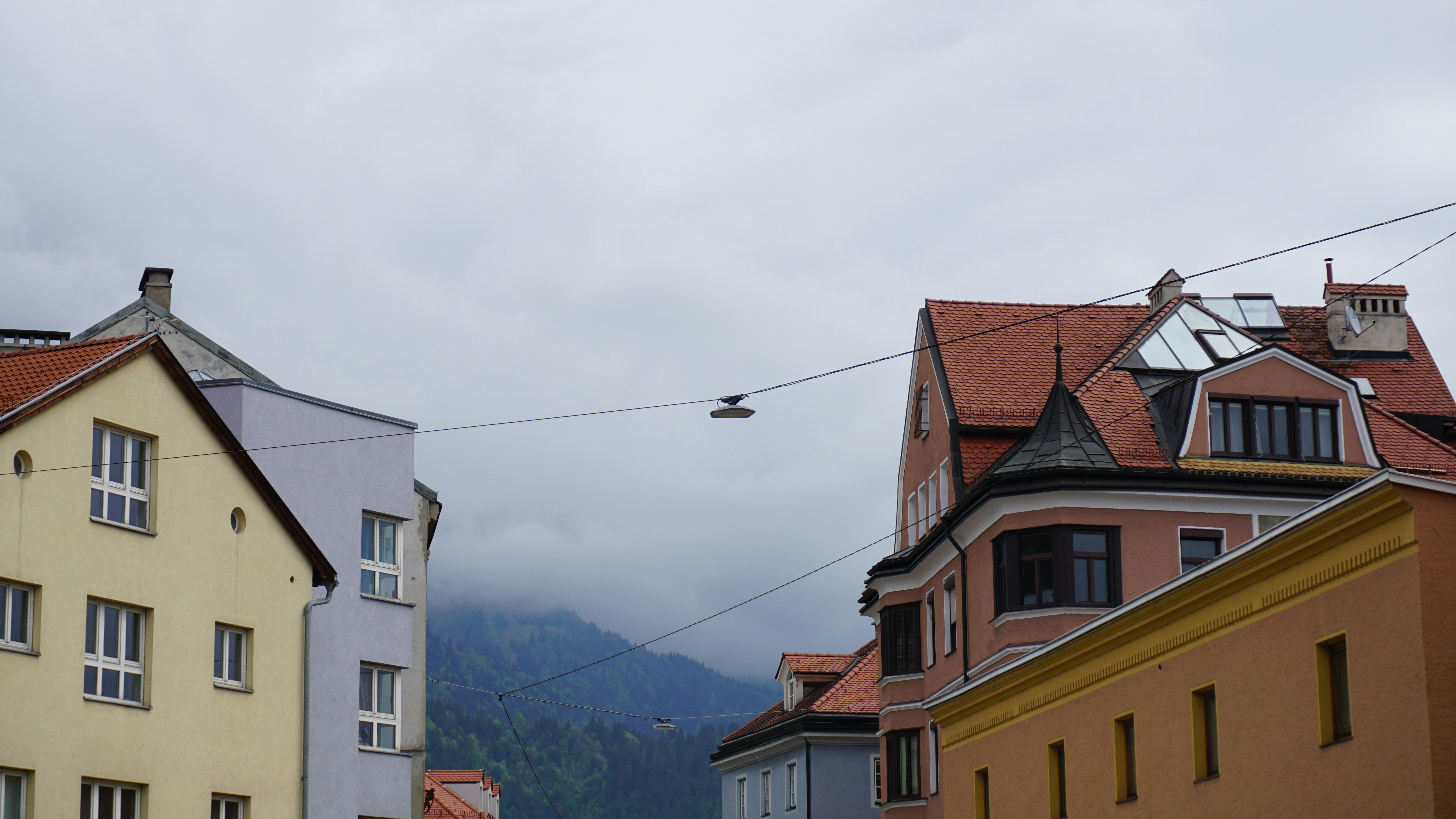 Bird on a Wire Over a Colorful Alpine Street
