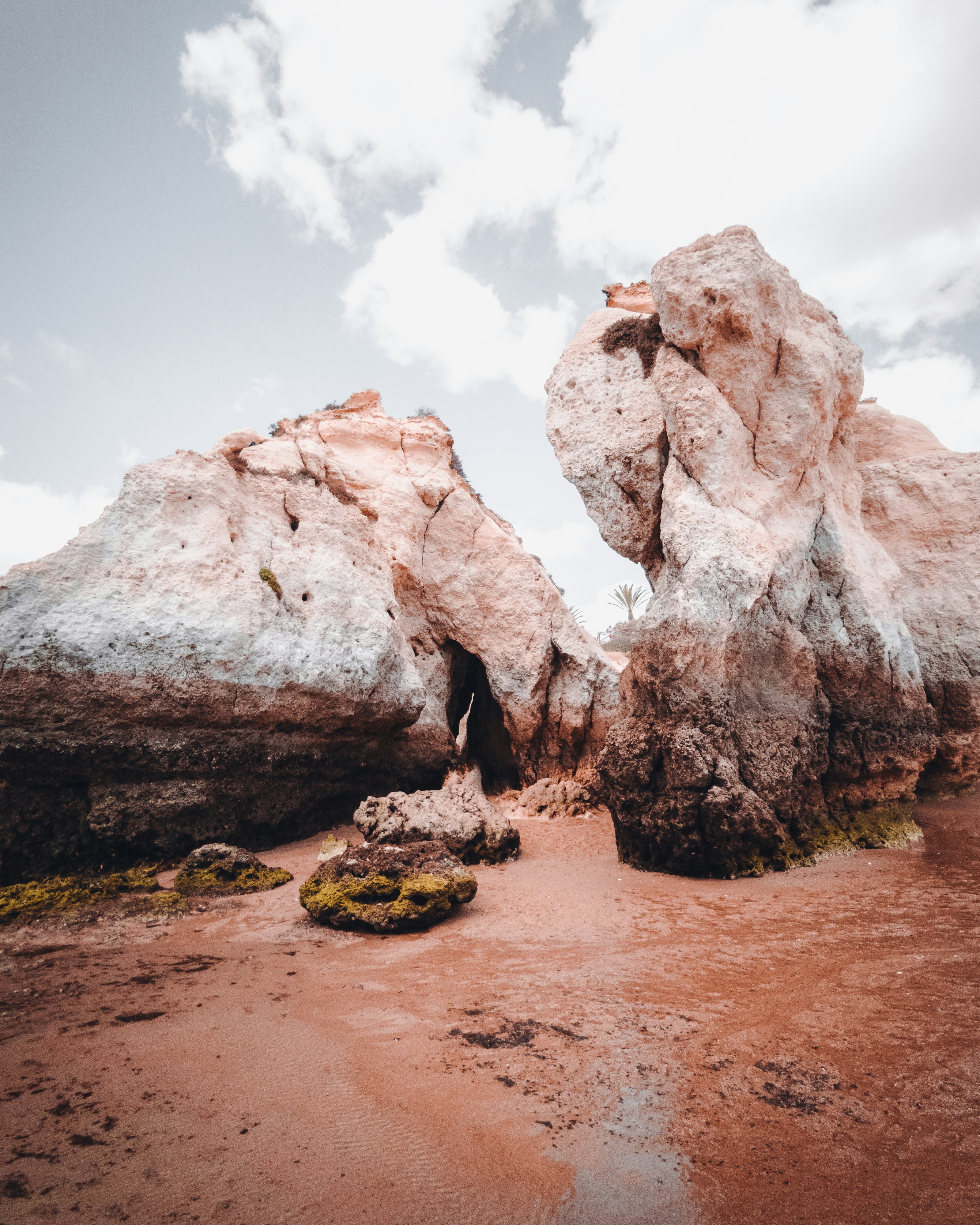 Desert Tidal Gate: Weathered Columns Against a Carved Shore