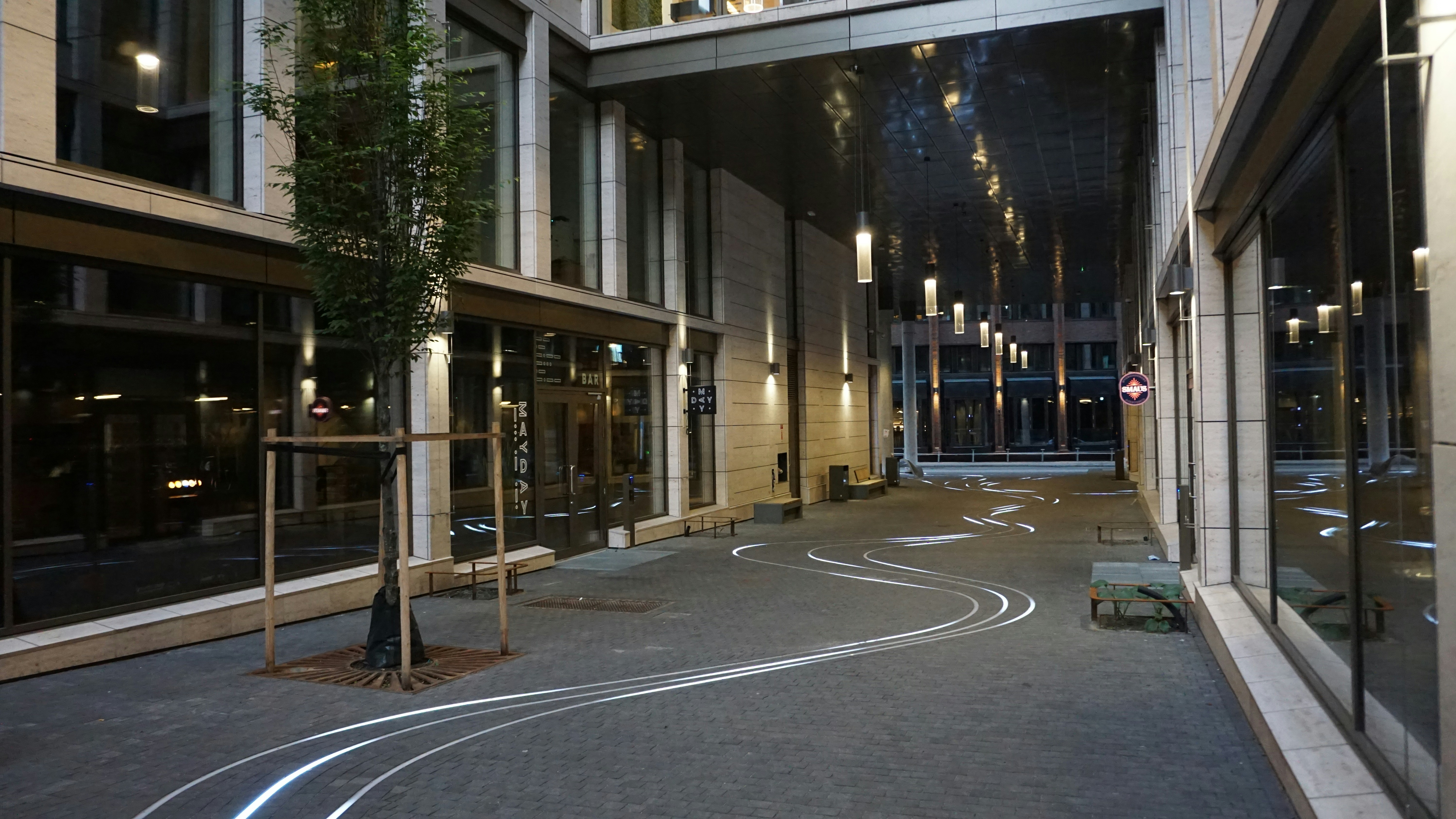 A city street with a curved road in front of a building photo – Free ...