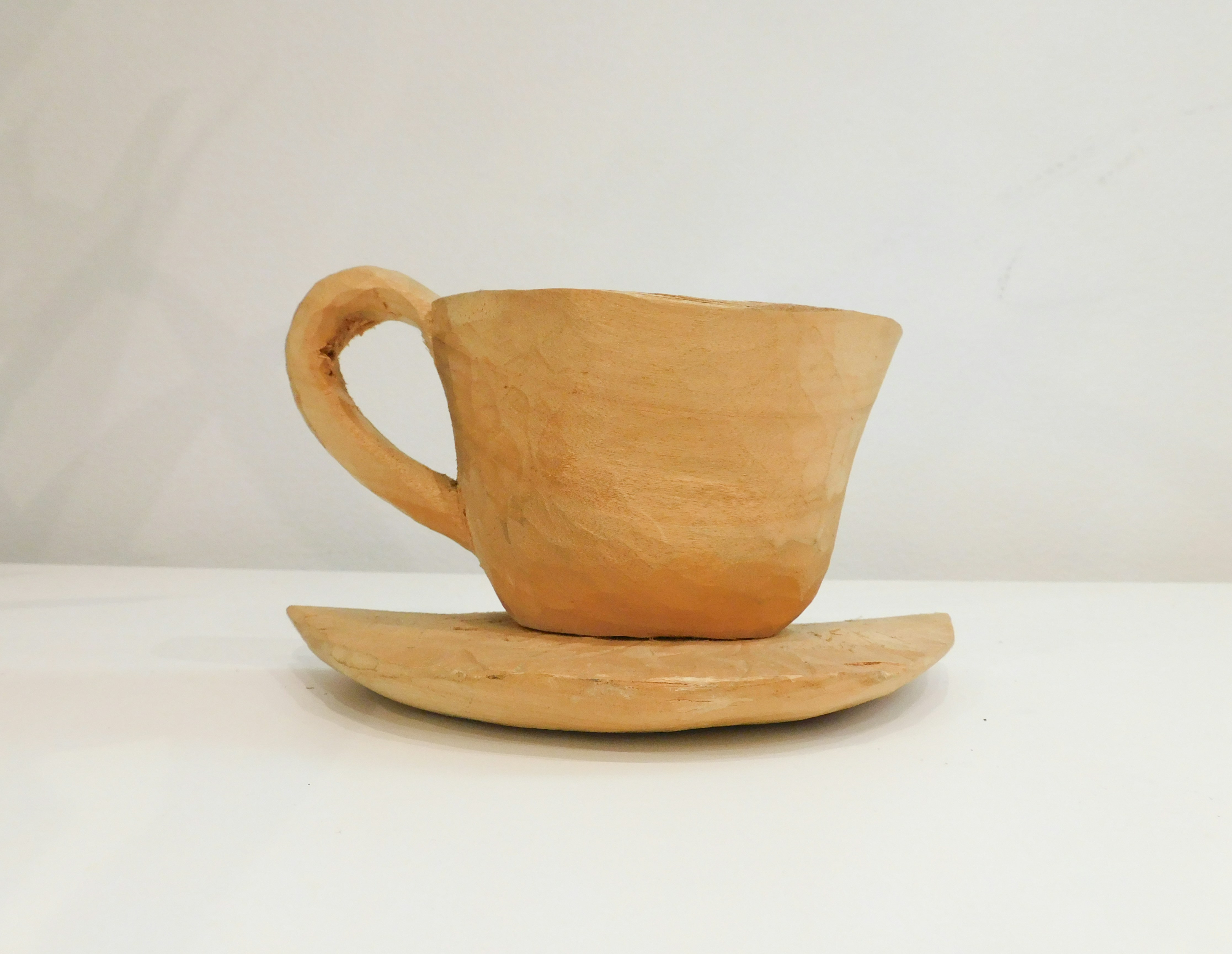 A wooden cup and saucer sitting on a plate photo – Free Cup Image on ...