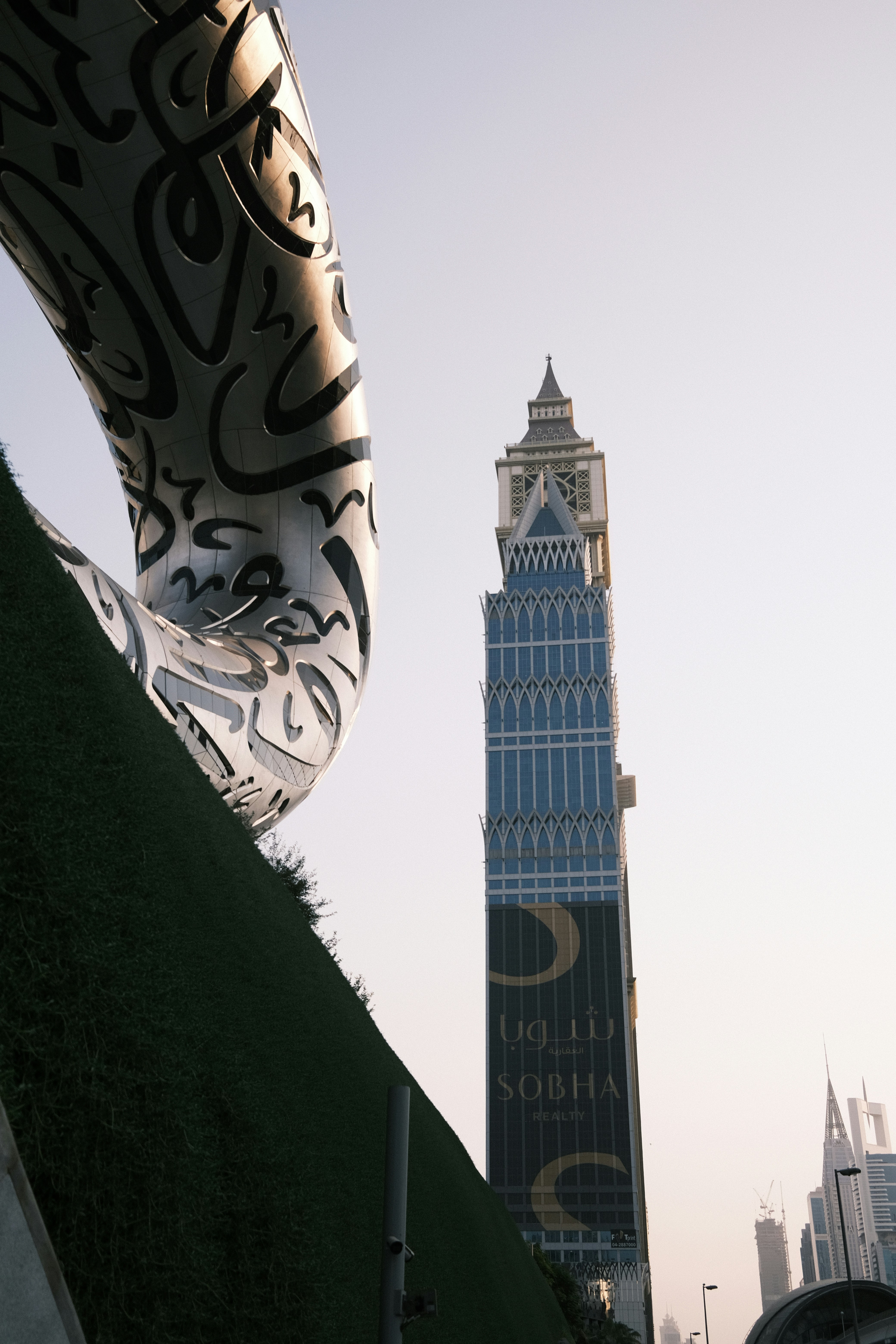 Vertical Icon: The Clock Tower Rising Over a Curved Metallic Facade
