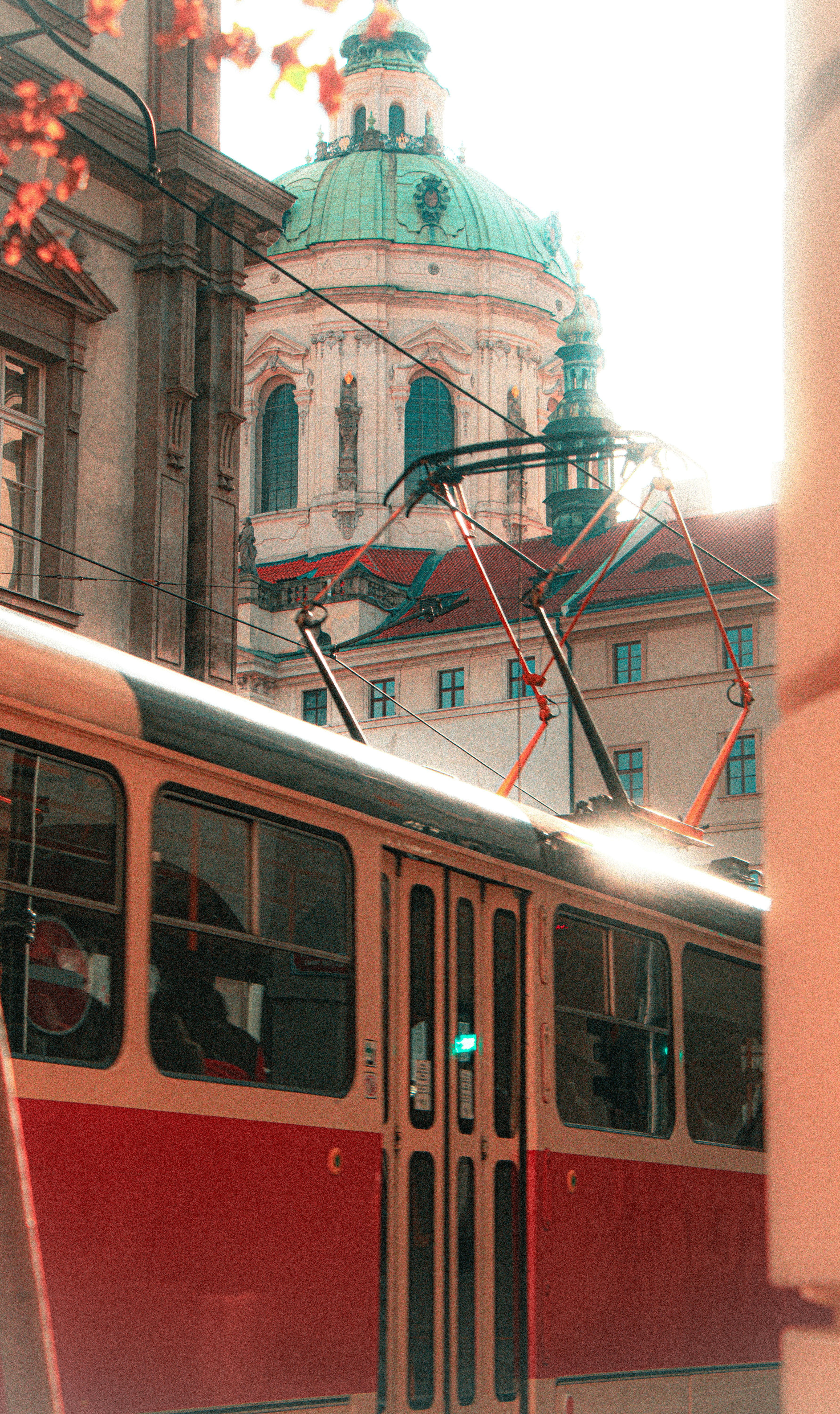 Emerald Dome, Red Rails: A City Tram Under an Architectural Sky