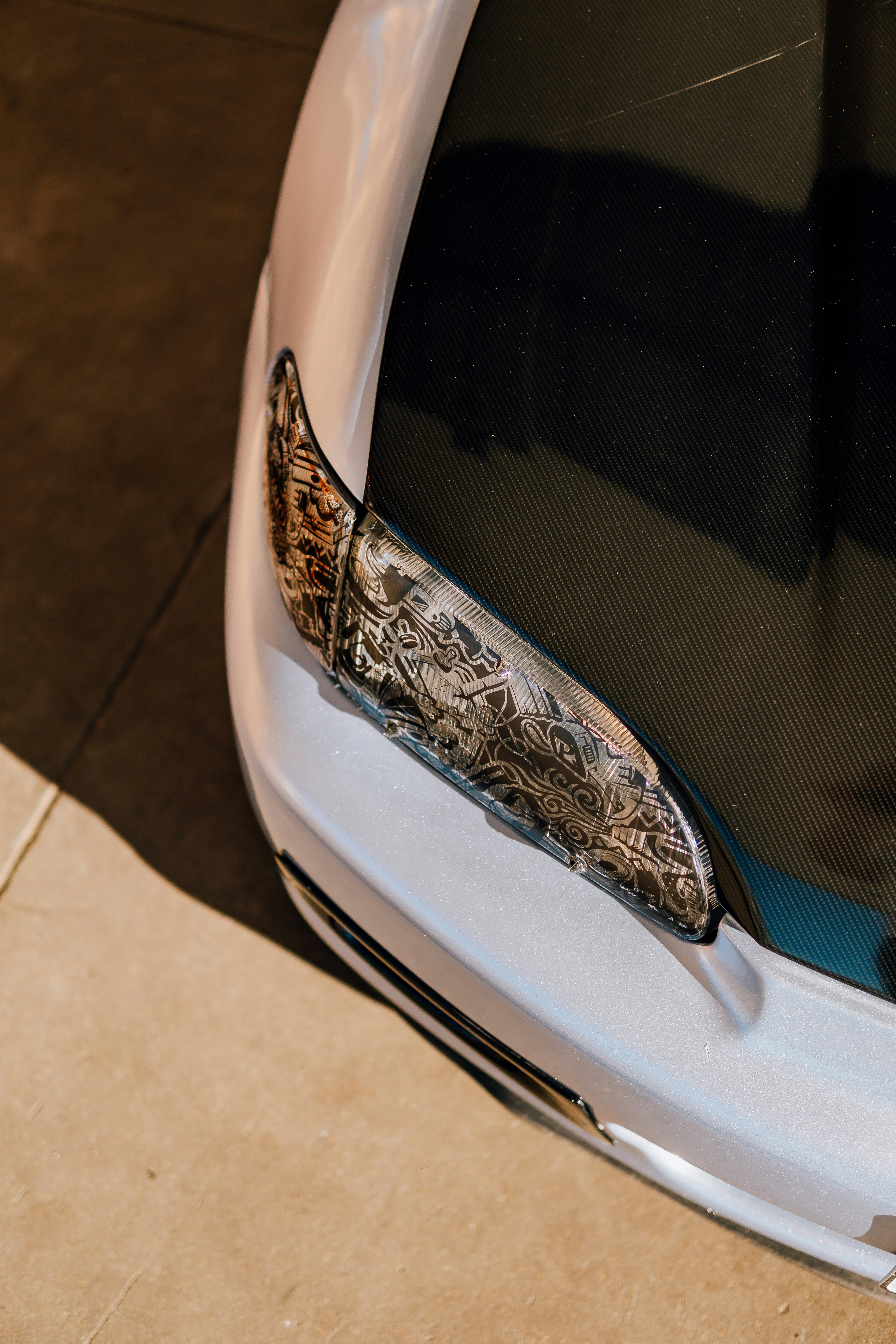 Carved chrome gleam: the hood ornament of a concealed machine