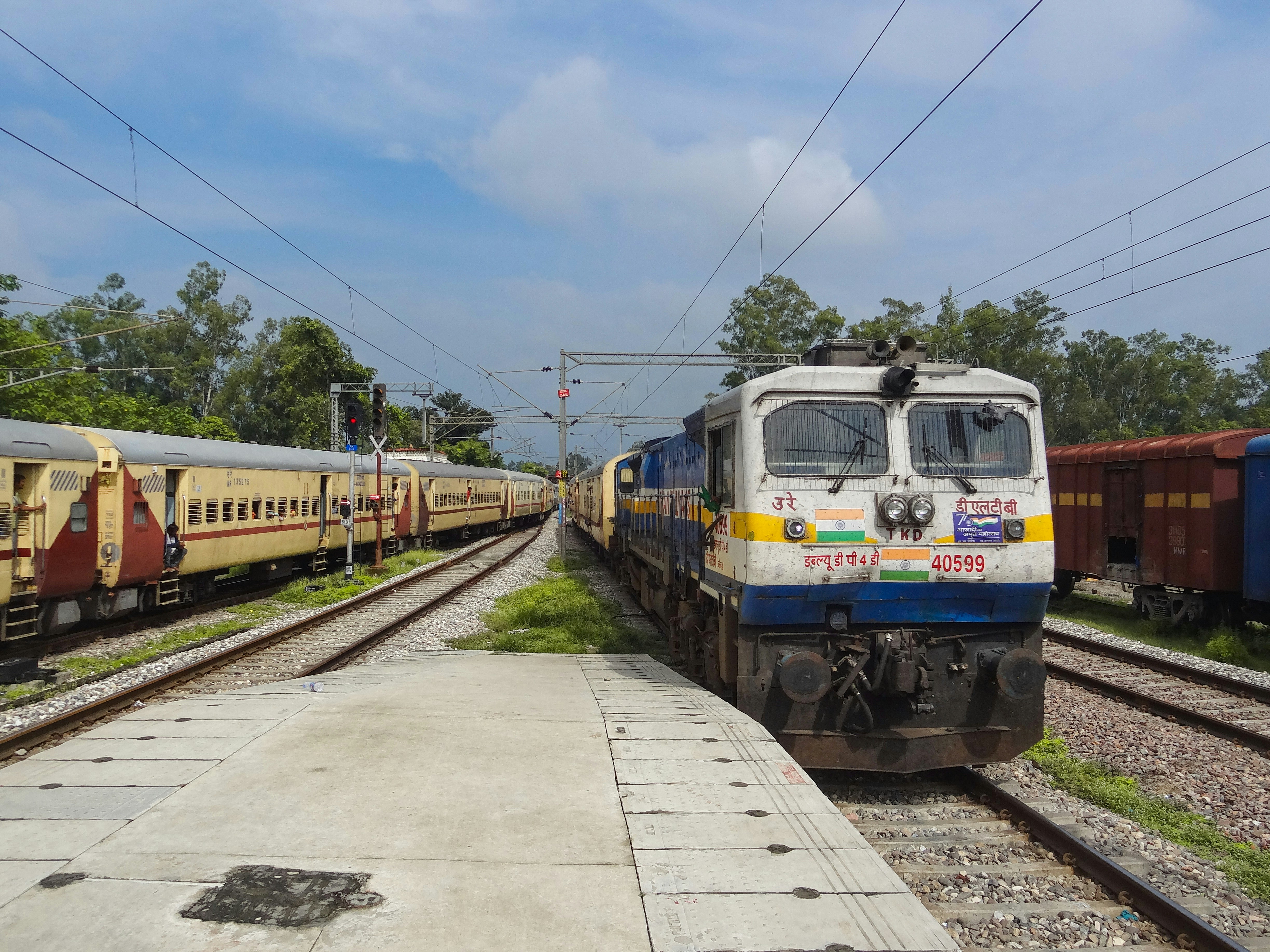 A couple of trains that are sitting on the tracks photo – Free Roorkee ...