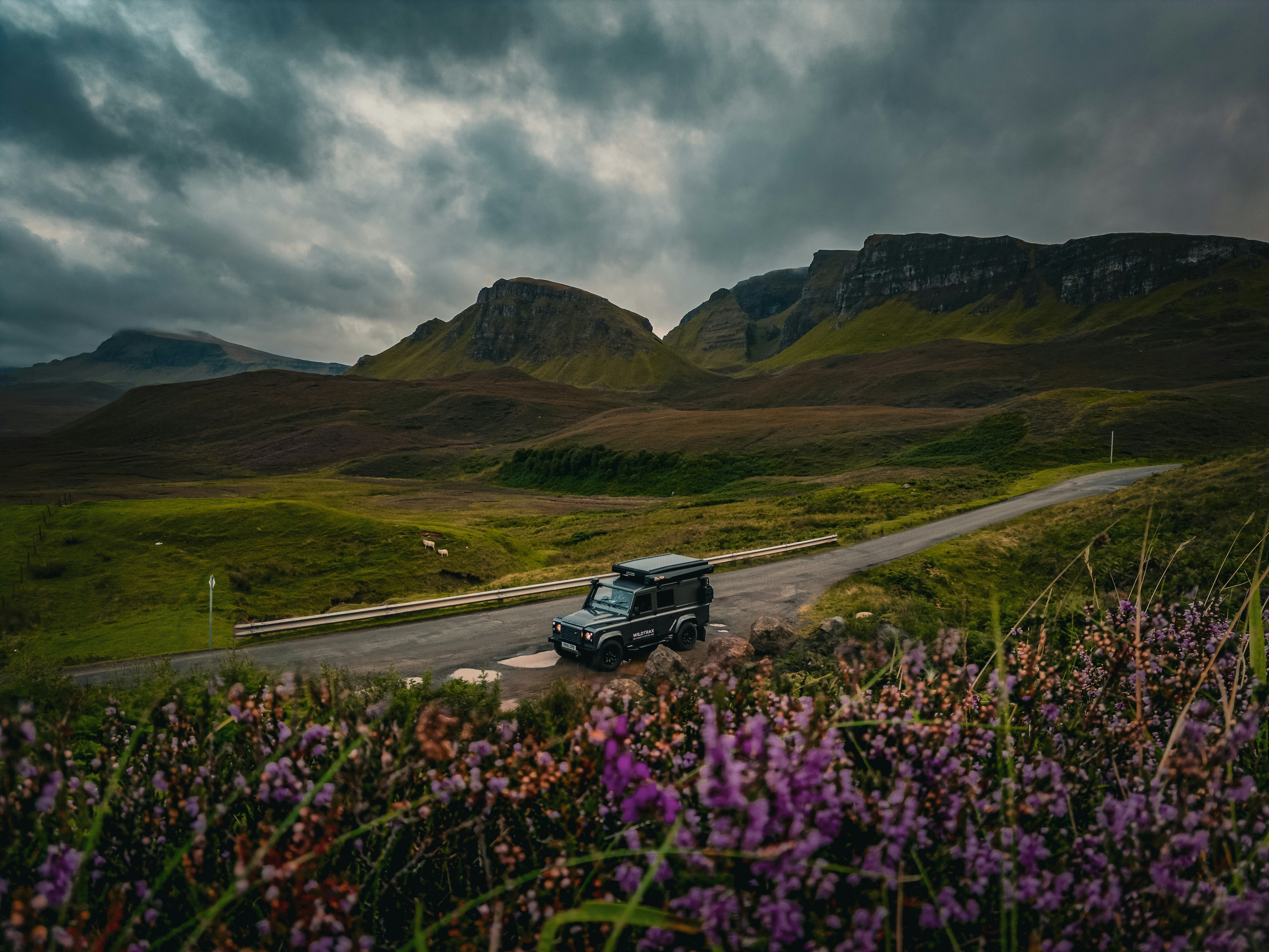 Jeep on the Moor: A Winding Highland Road Under Stormy Skies