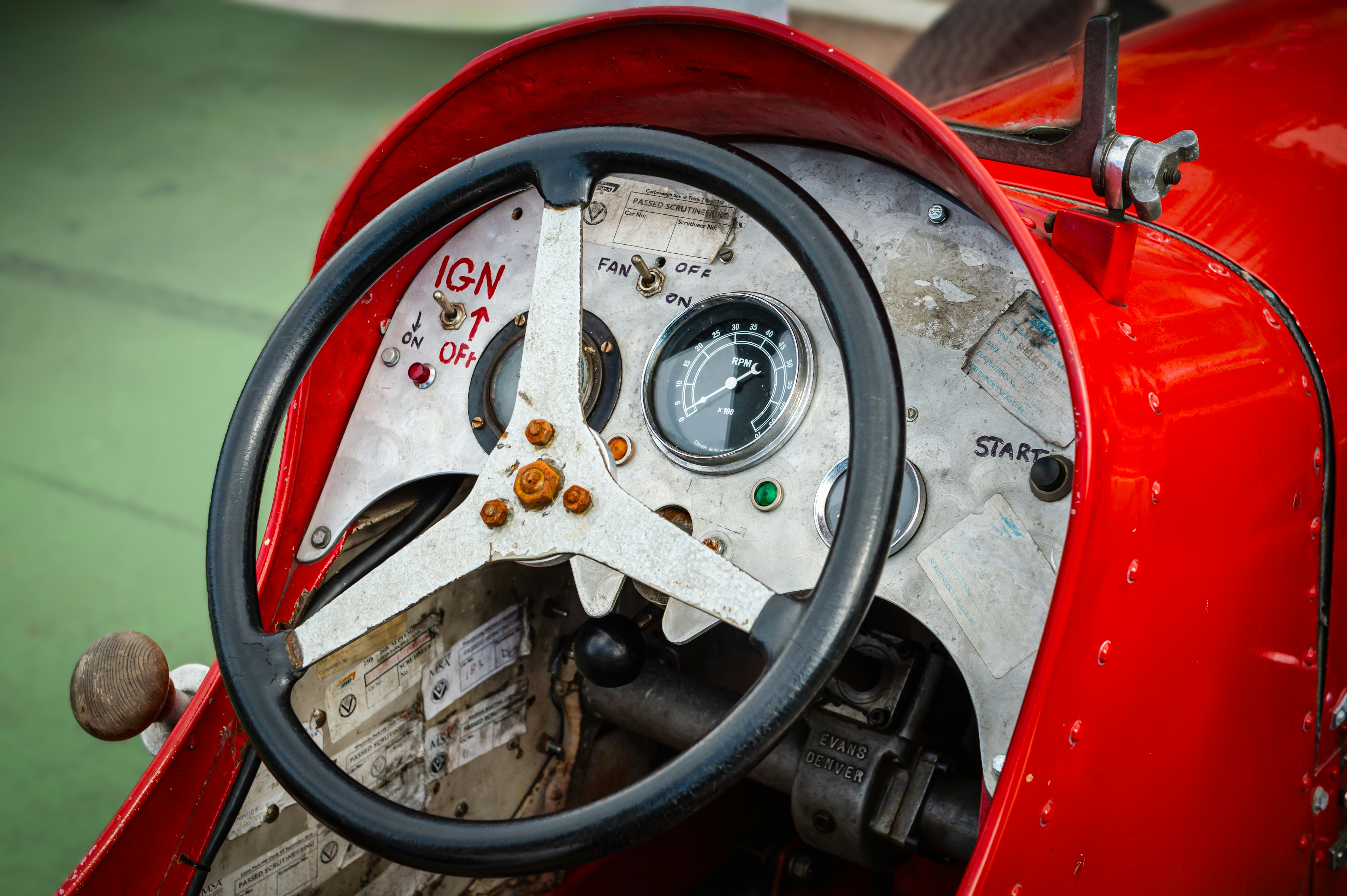 Weathered Red Cockpit: A Vintage Flight Control Wheel in Focus