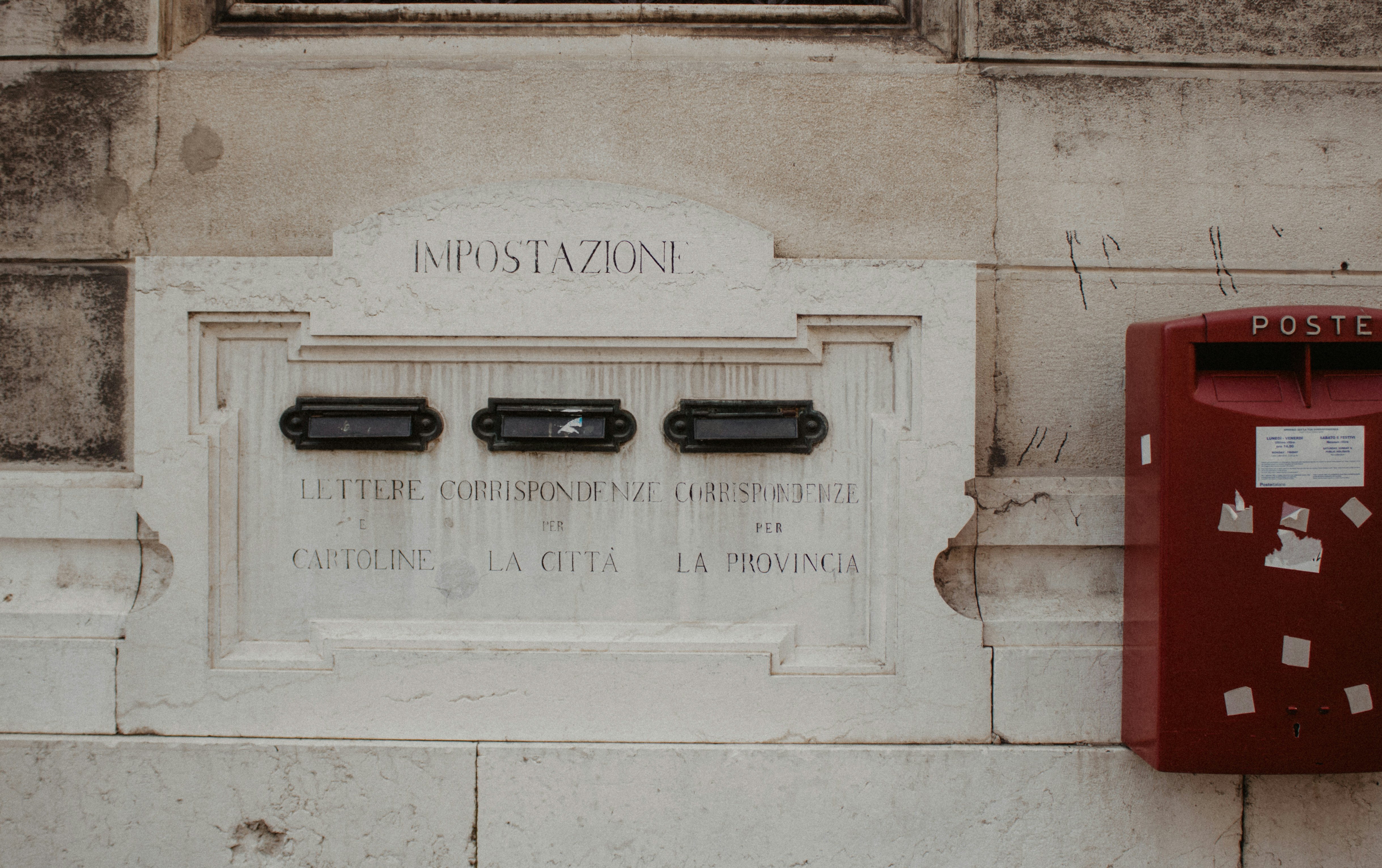 Crimson Messenger Against a Weathered Stone Facade