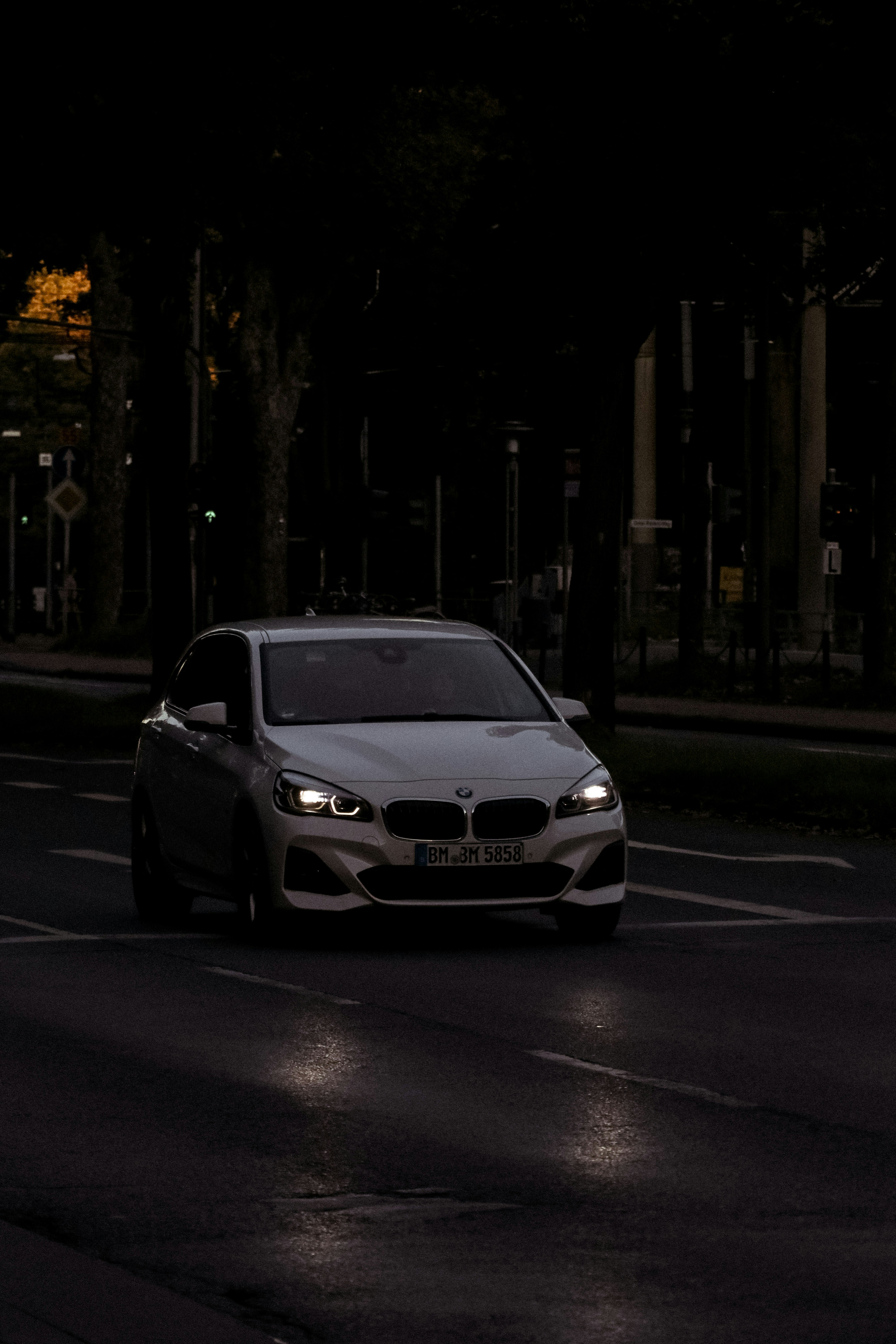 Night Drive in White: A BMW Meets Streetlight Glow