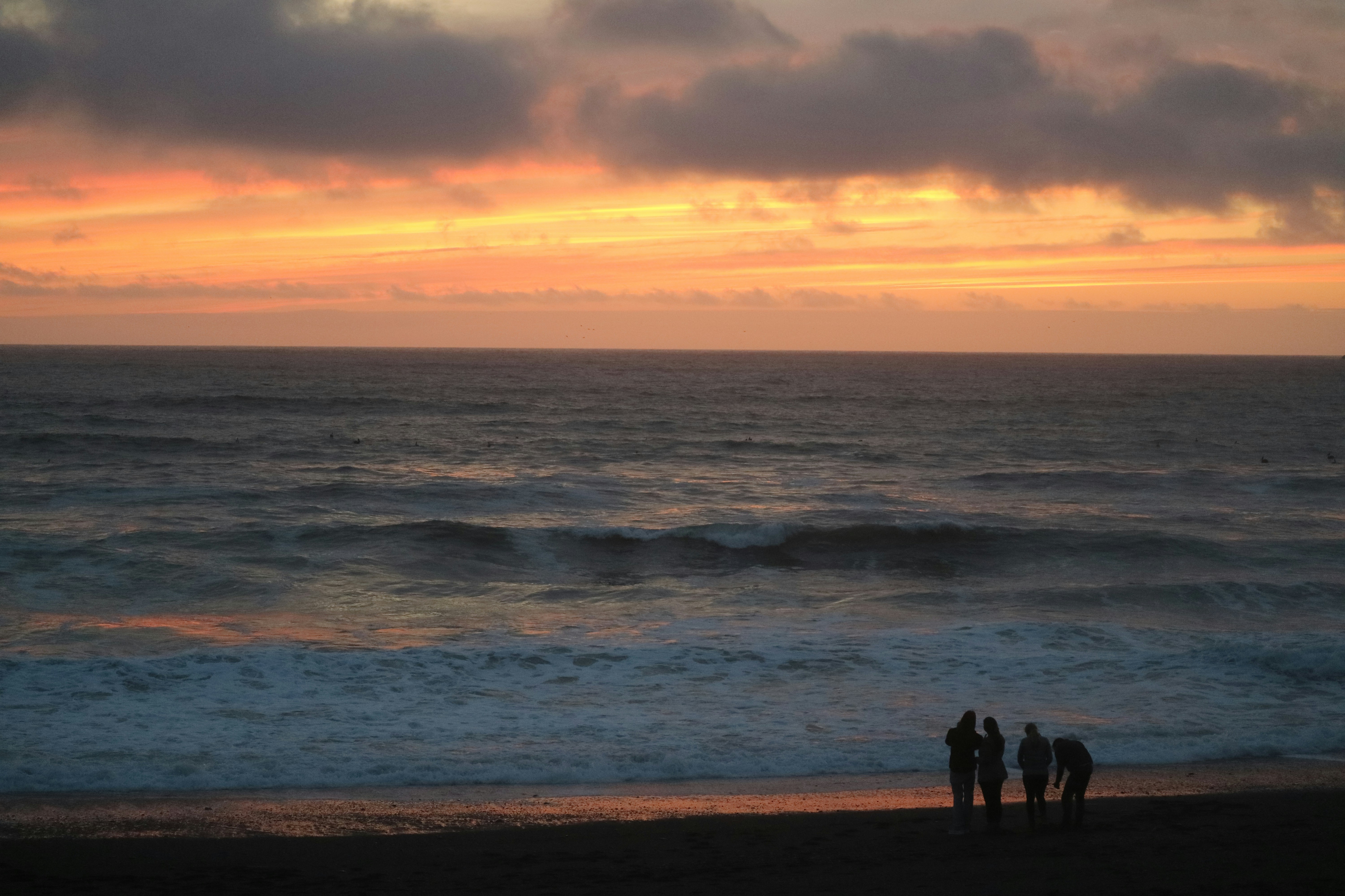 Sunset Silhouette: A Small Group at the Waterline