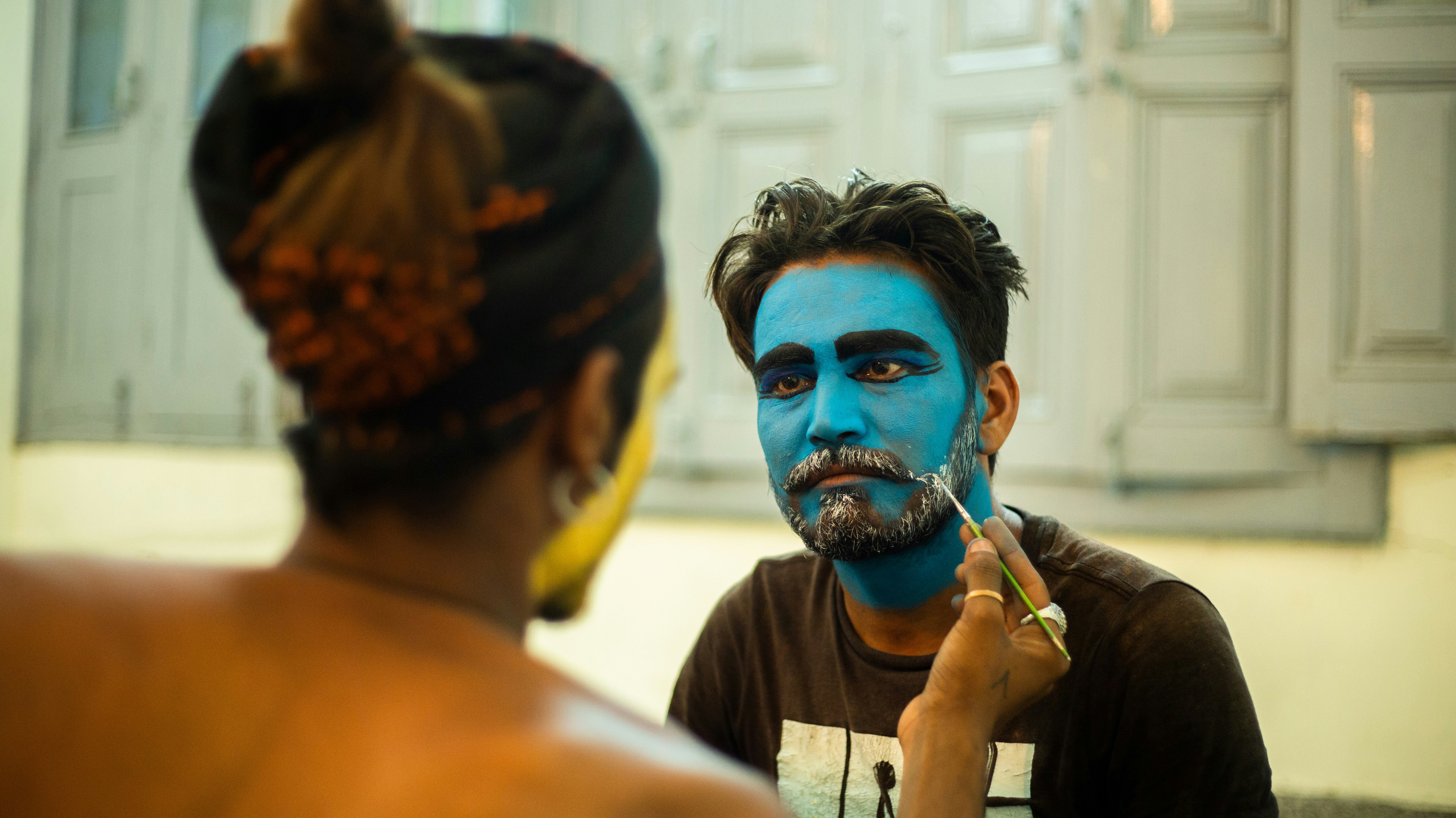 A man is getting his face painted blue photo – Free Man Image on Unsplash