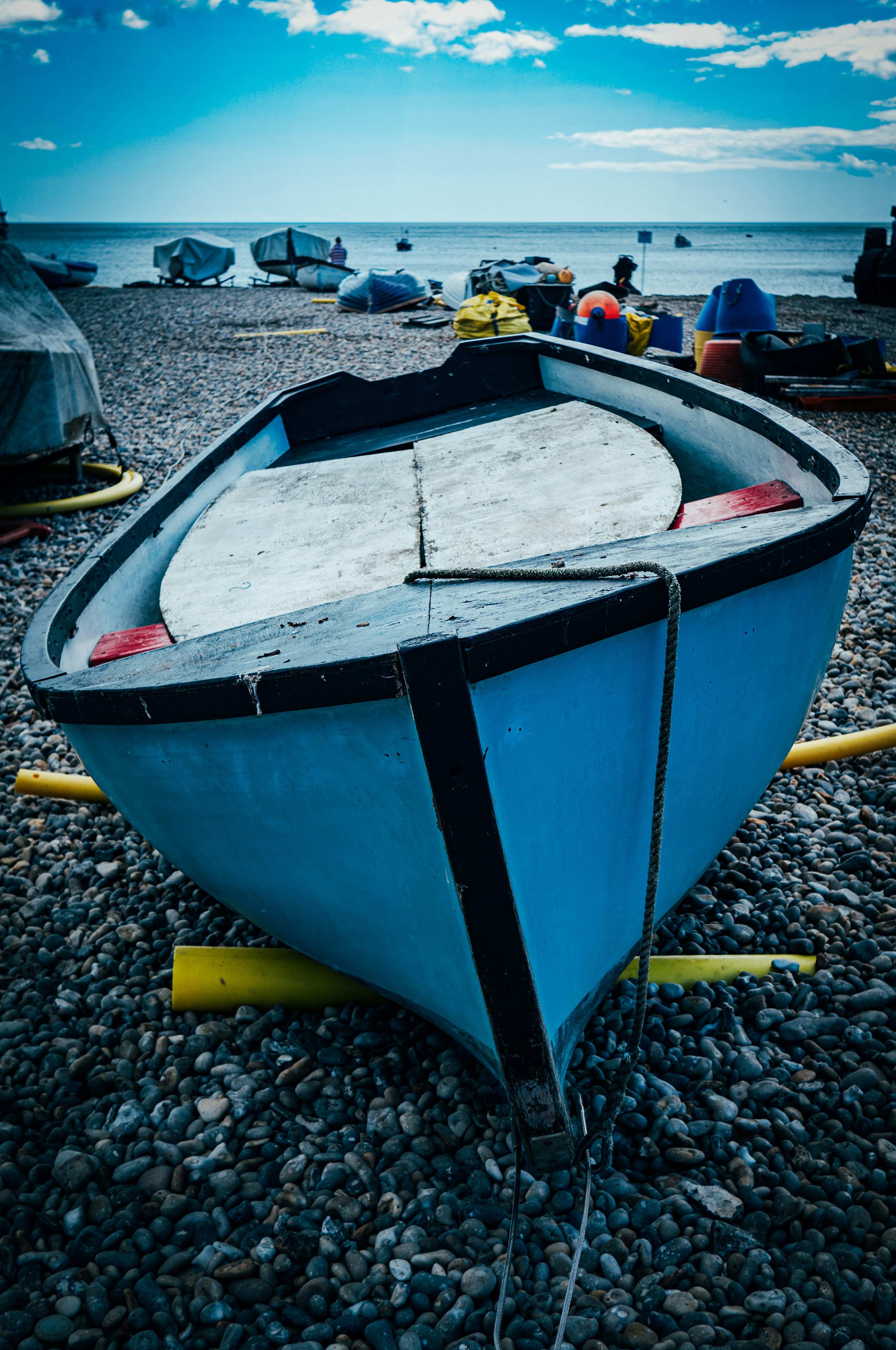 Blue Hull on a Pebble Shore: A Quiet Harbor Portrait