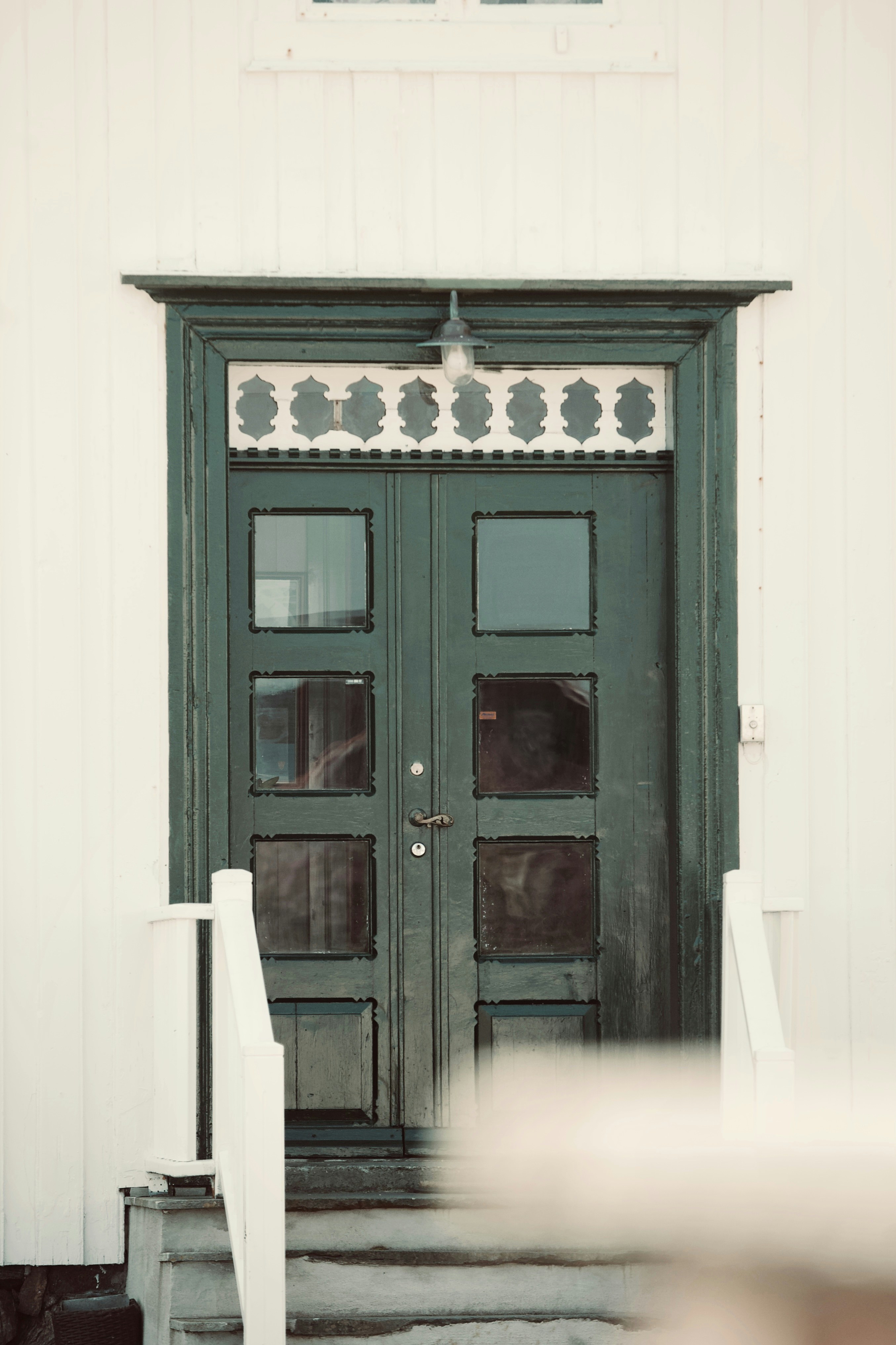 Green vintage door on white building