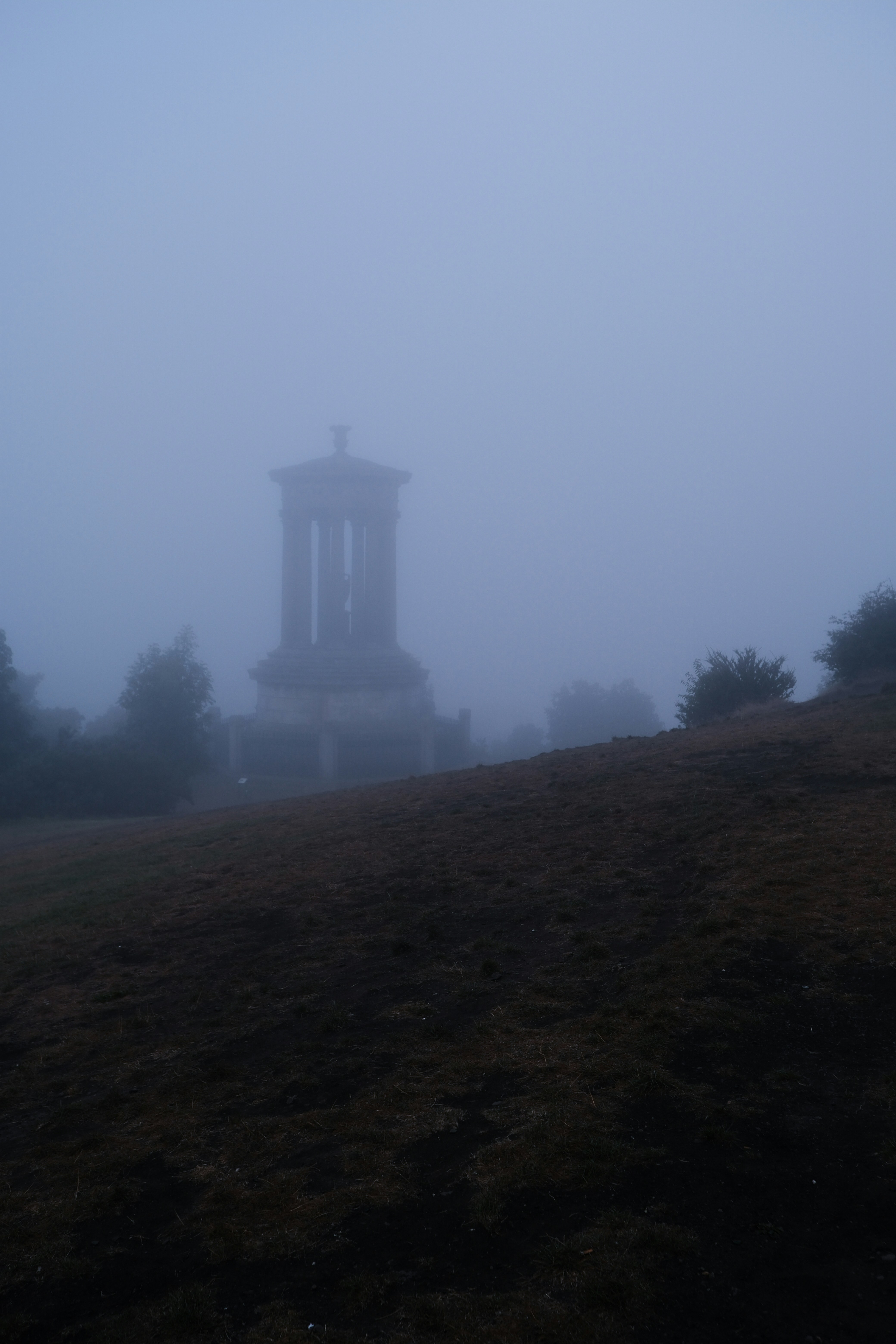 The Veiled Rotunda: A Hilltop Monument Emerges from the Fog