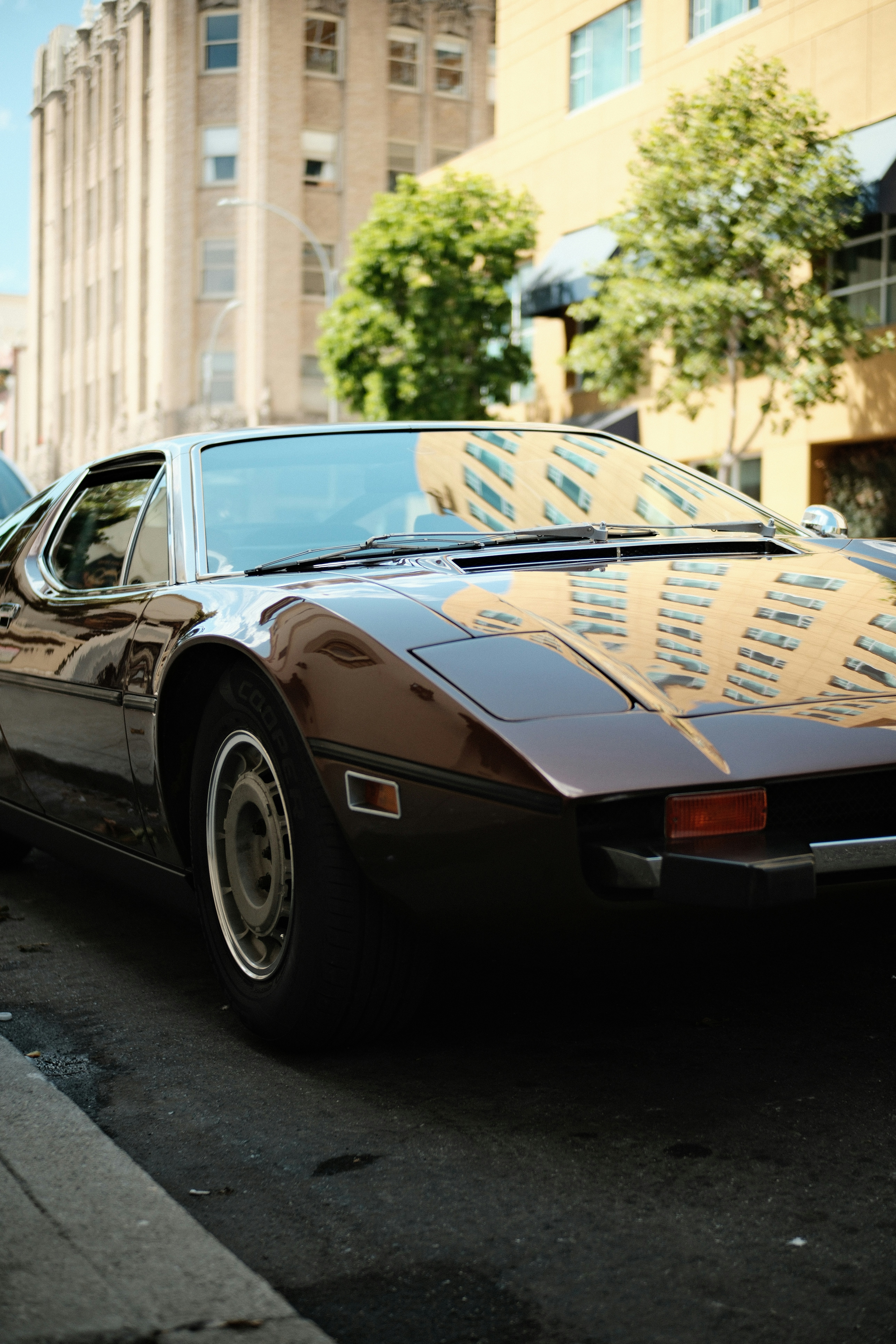 Low-profile Classic: A Bursting Reflection on a Dusk-Red Ferrari