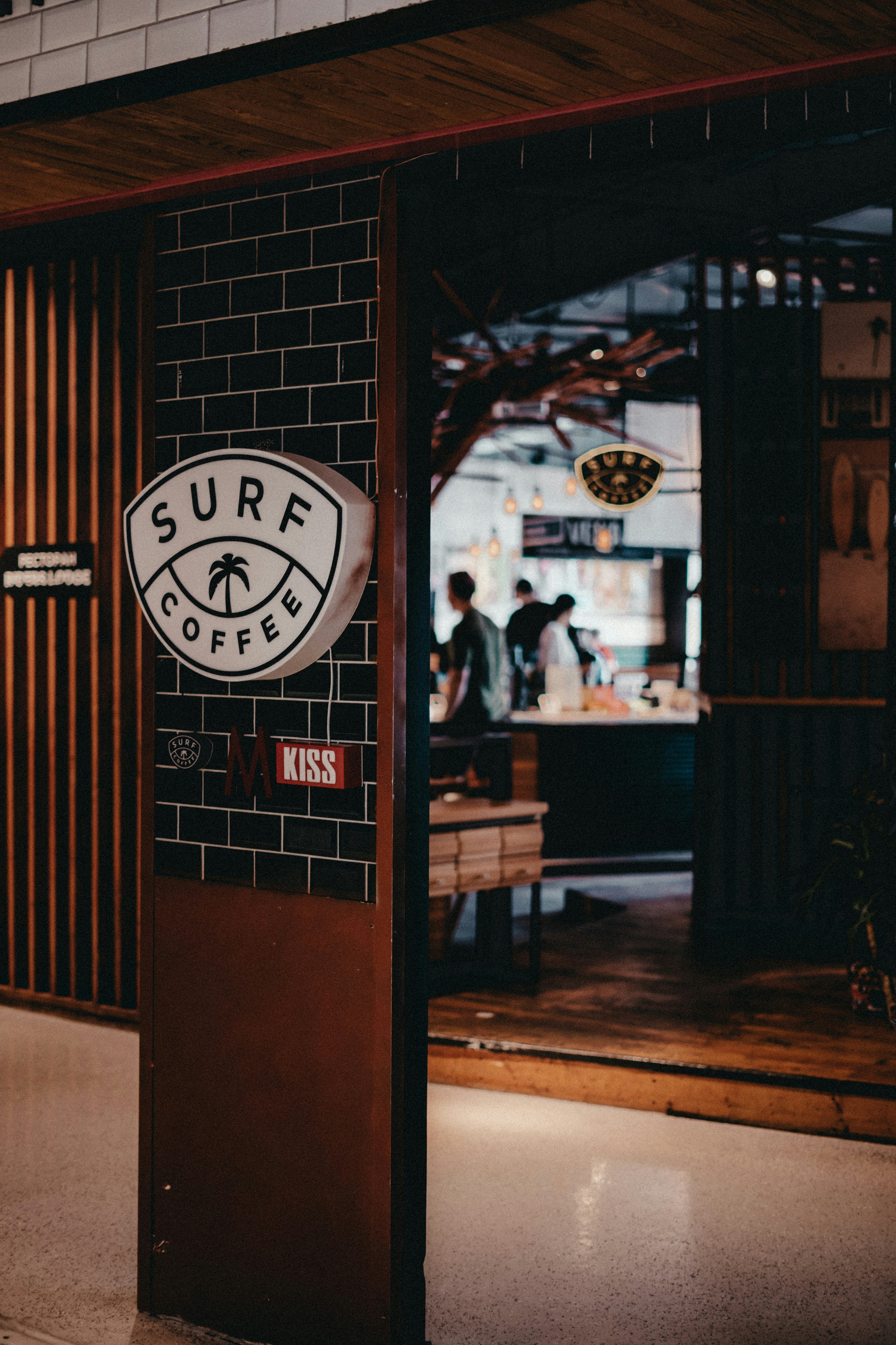 Doorway to the Brew: Surf Coffee Sign Framing a Quiet Café