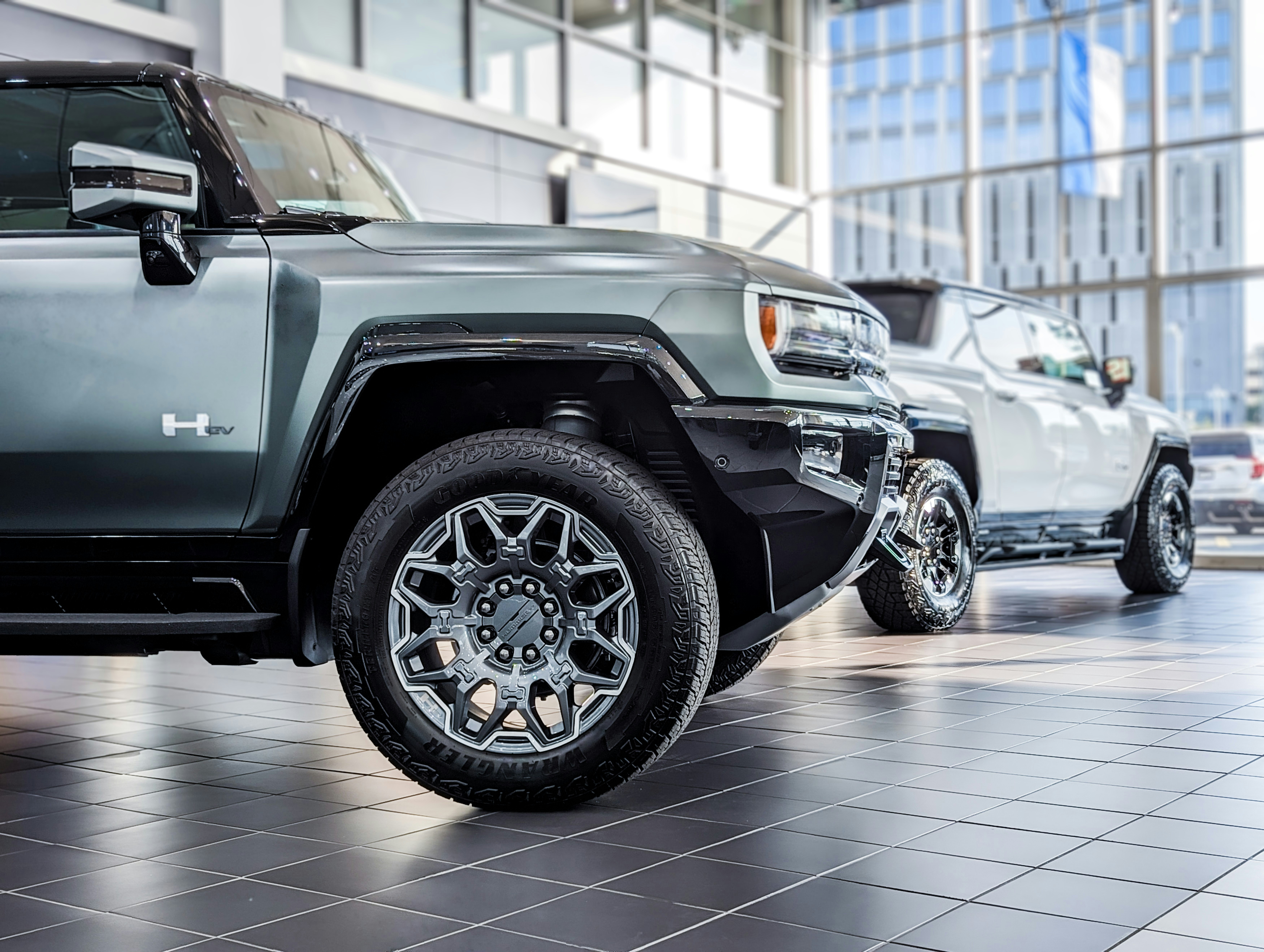 A grey hummer truck parked in front of a building photo – Free Machine ...