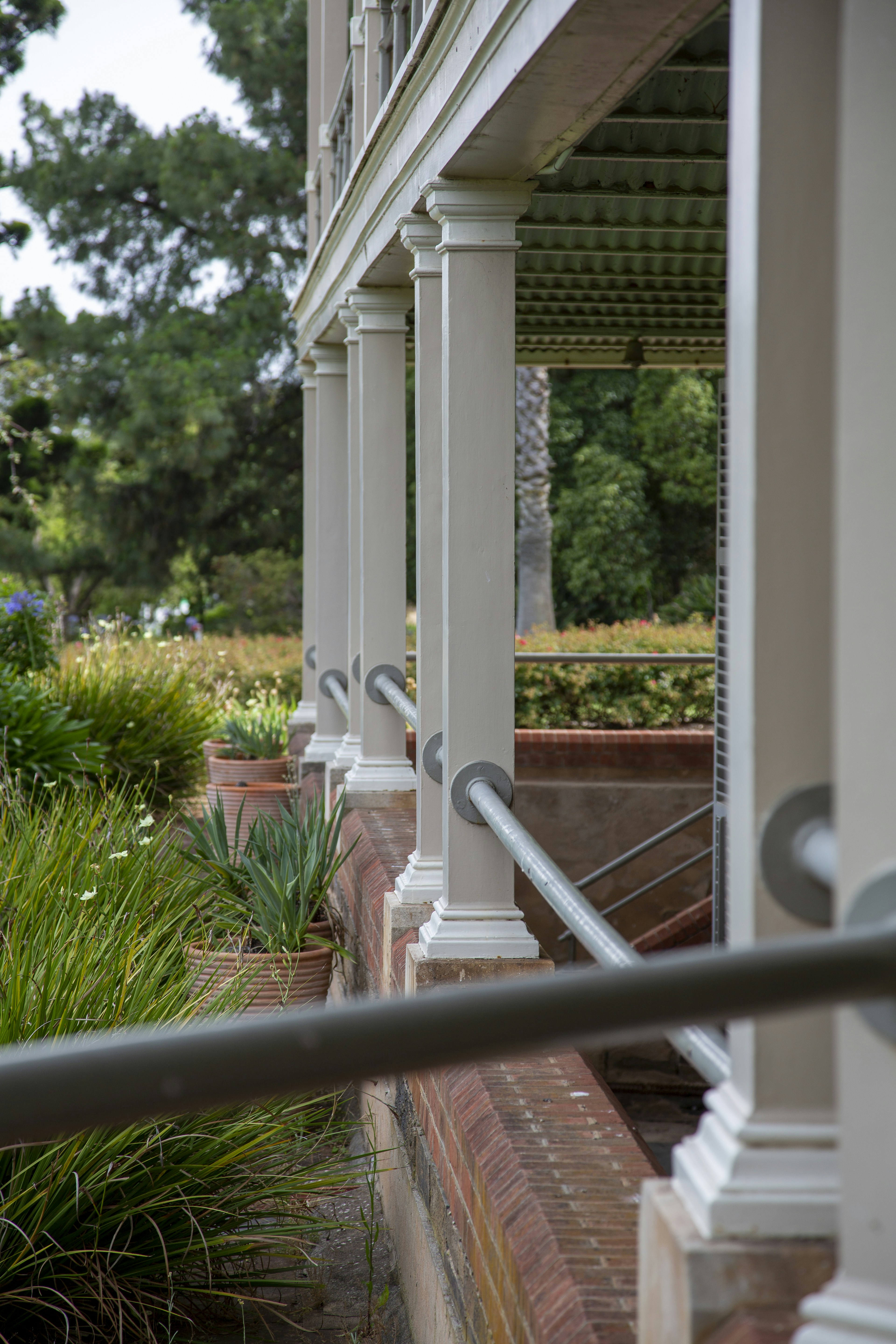 Symmetry in Shade: Columns Framing a Garden-Veranda Walk
