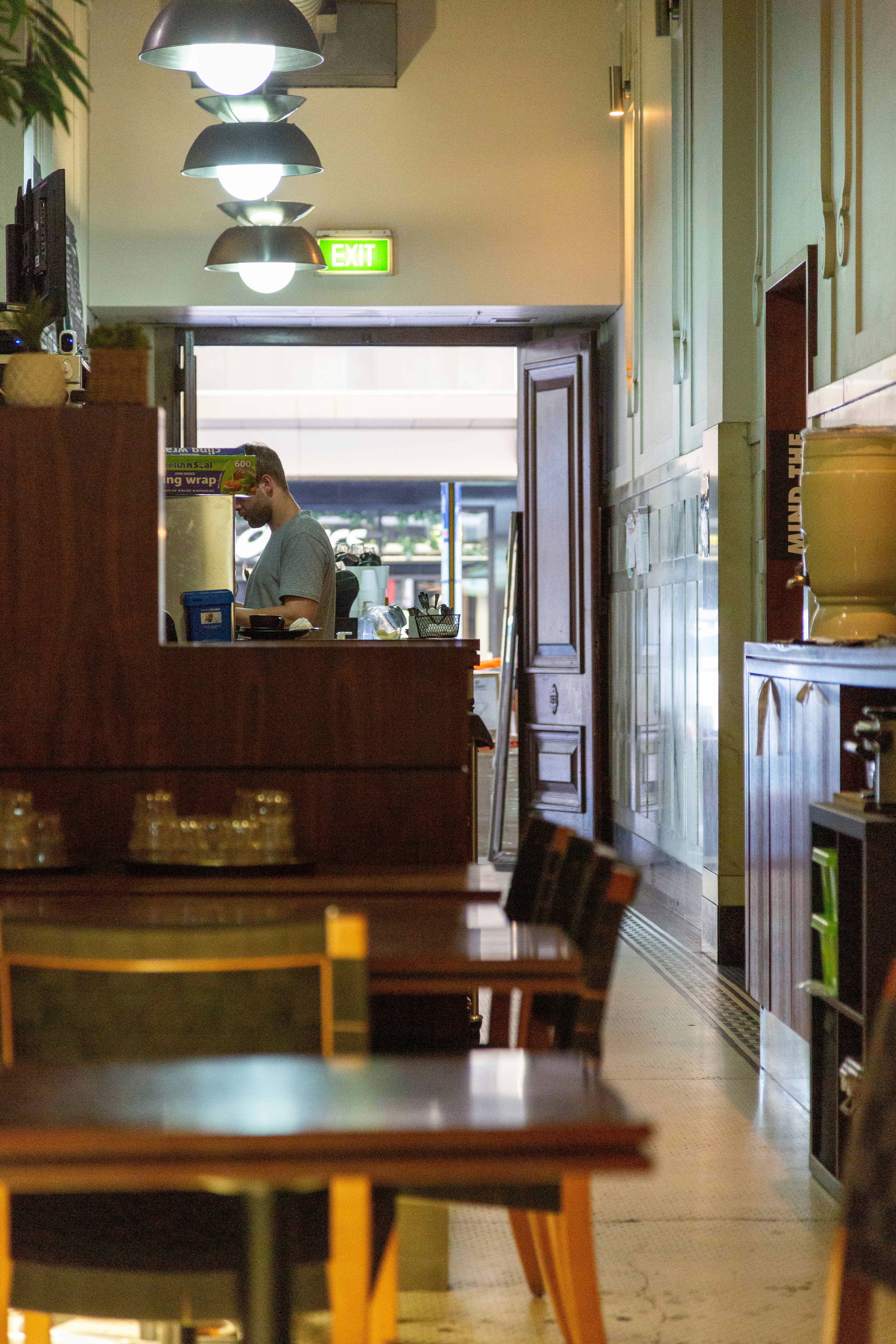 Cafe Counter Portrait: Barista at Distant View Through Corridor