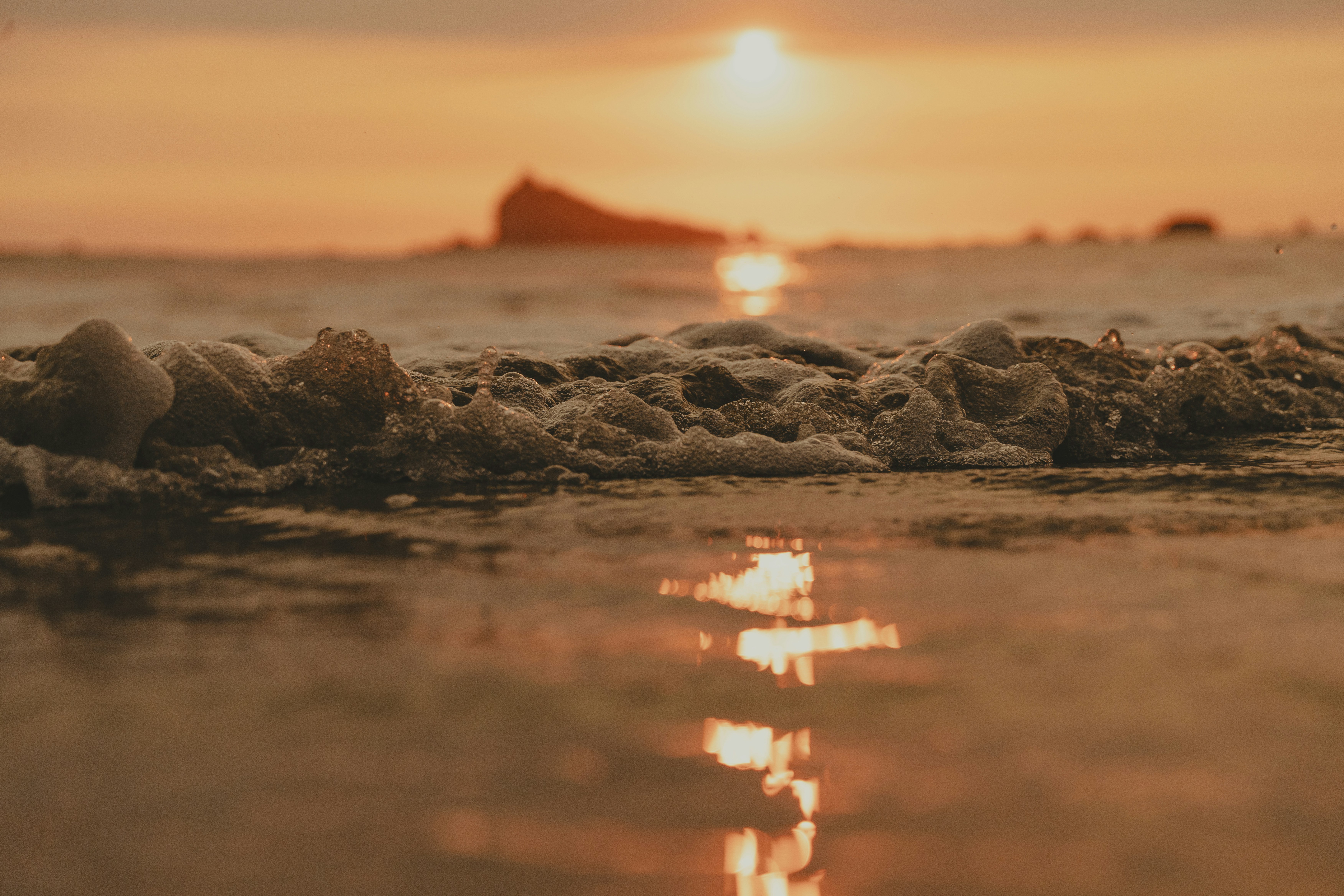 Pebble Echoes at Sunset: Gold on the Water