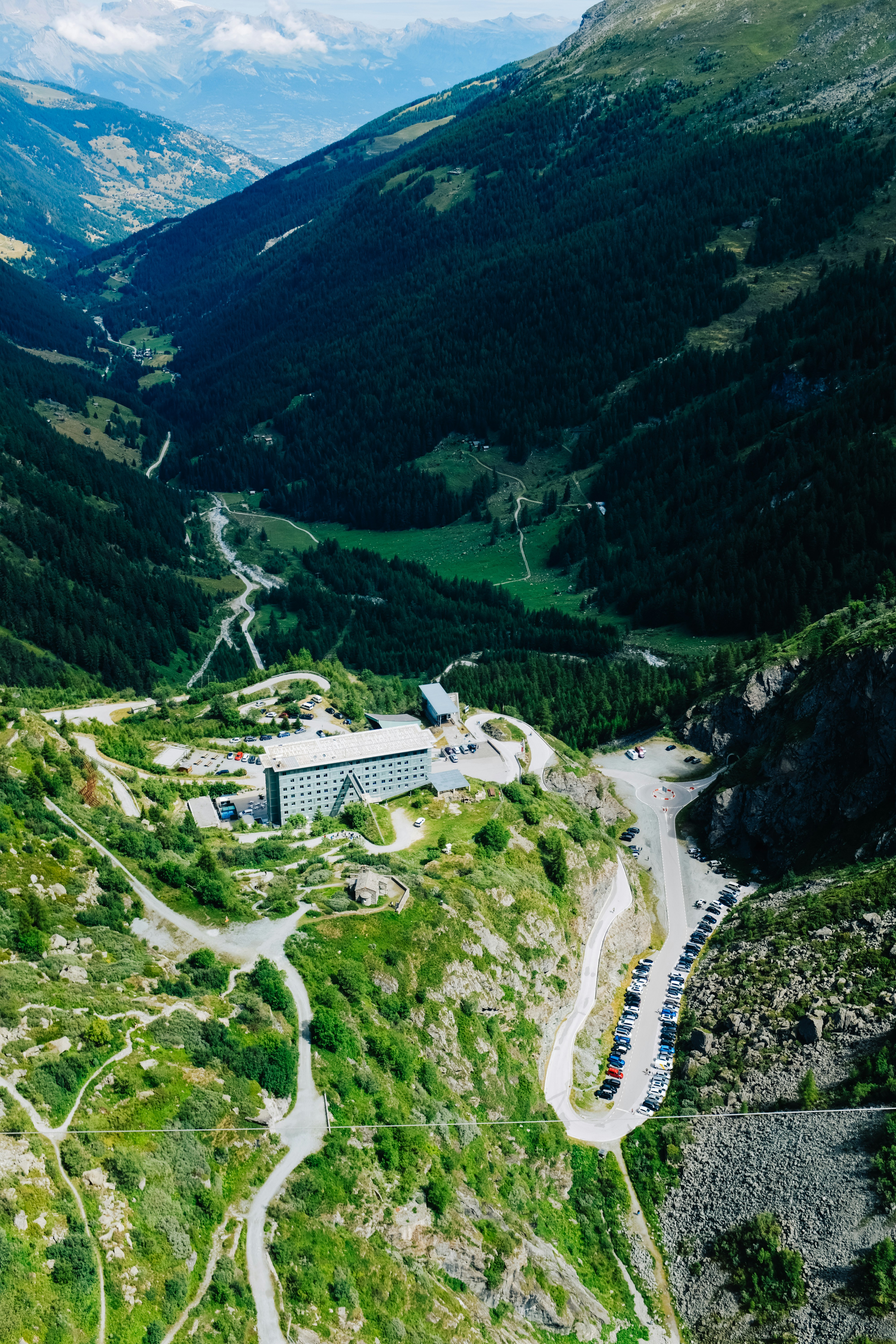 Alpine Lodge Cluster Nestled Along a Winding Valley Road