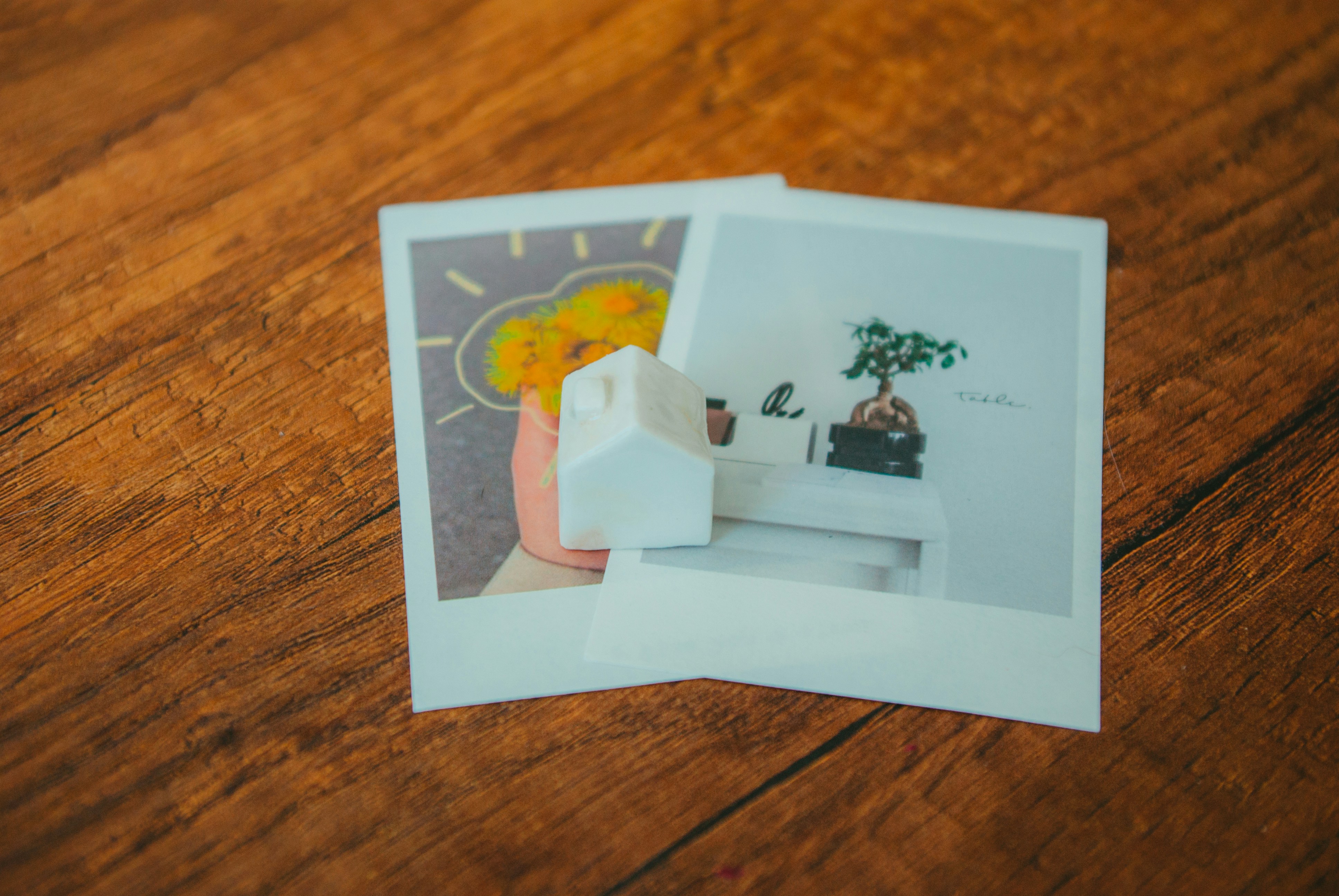Polaroid Fragments: A Quiet Still Life on Warm Wood