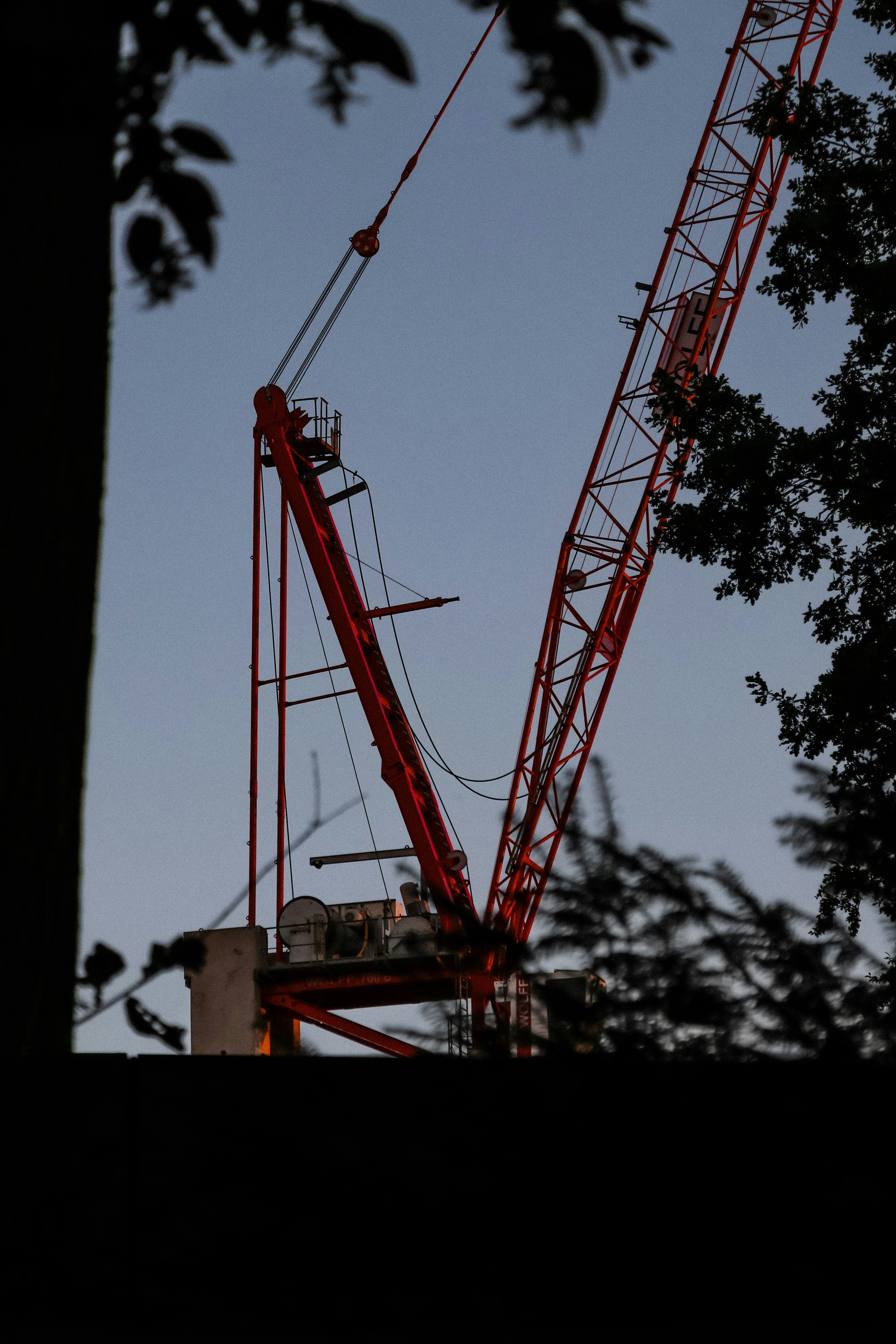 Crimson Crane Towers Against a Dusky Blue Sky