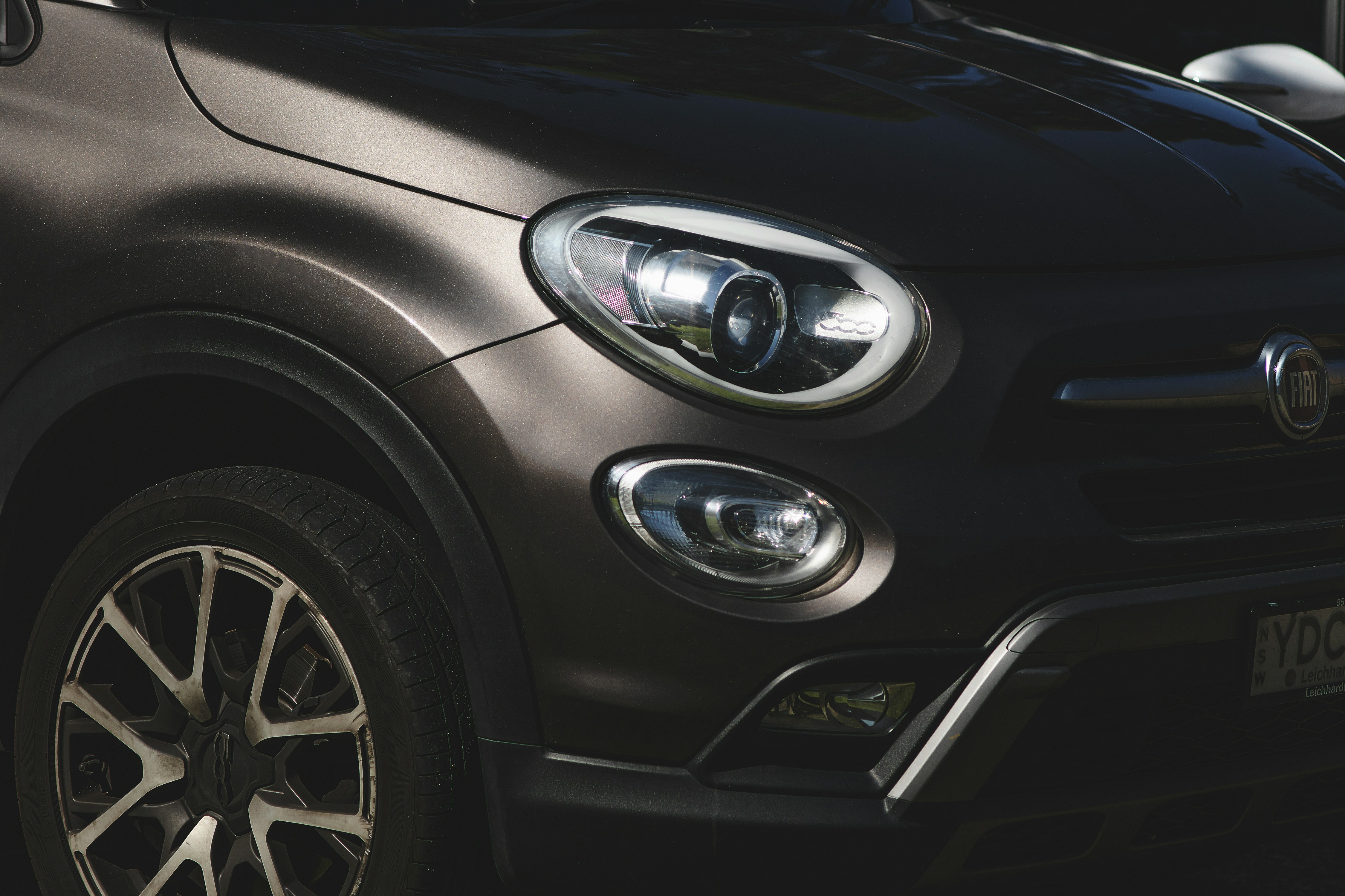 Dusky Fiat Front: Circular Headlights and Chrome Grille in Focus