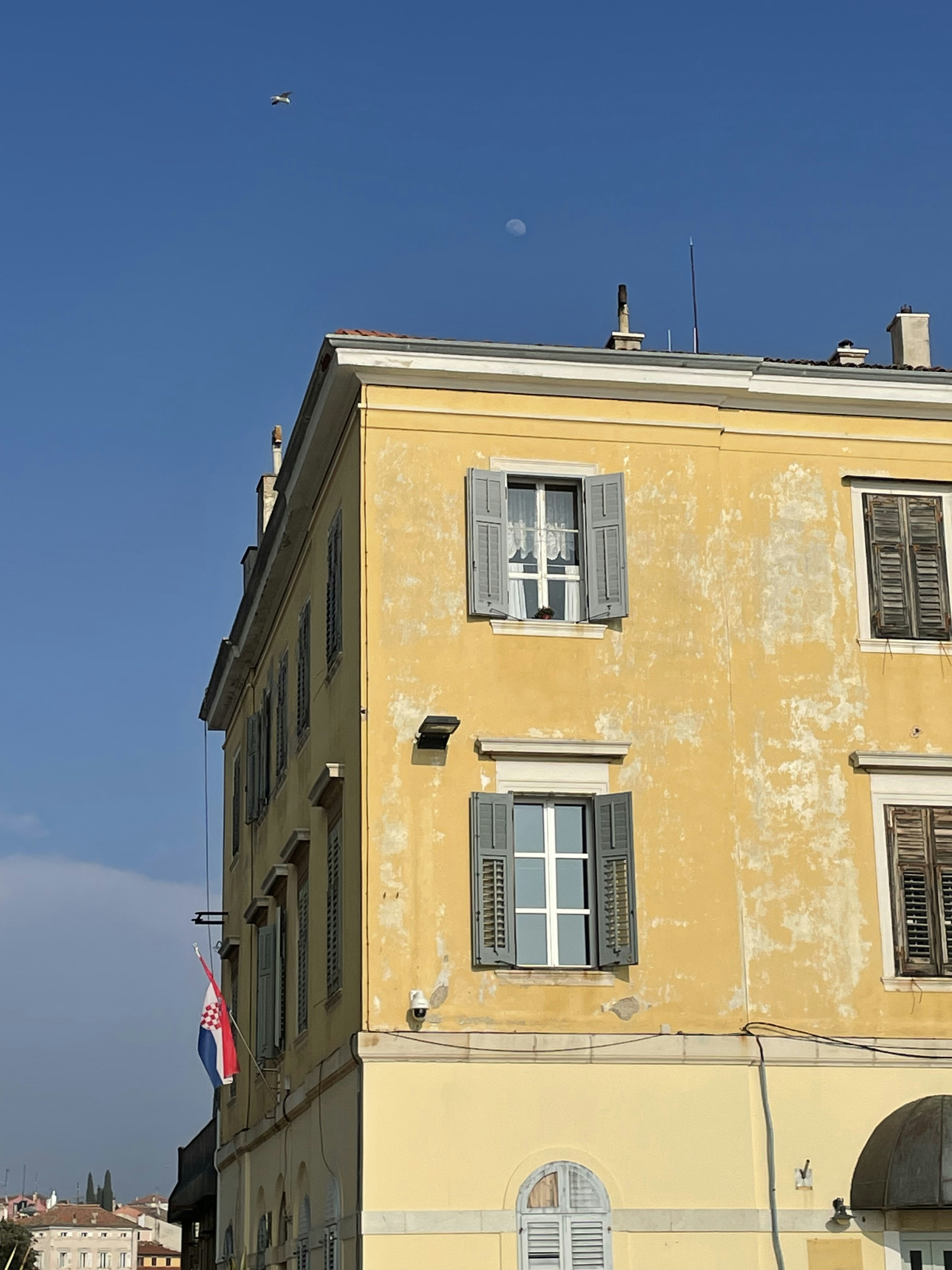 Golden Facade Under a Daytime Moon