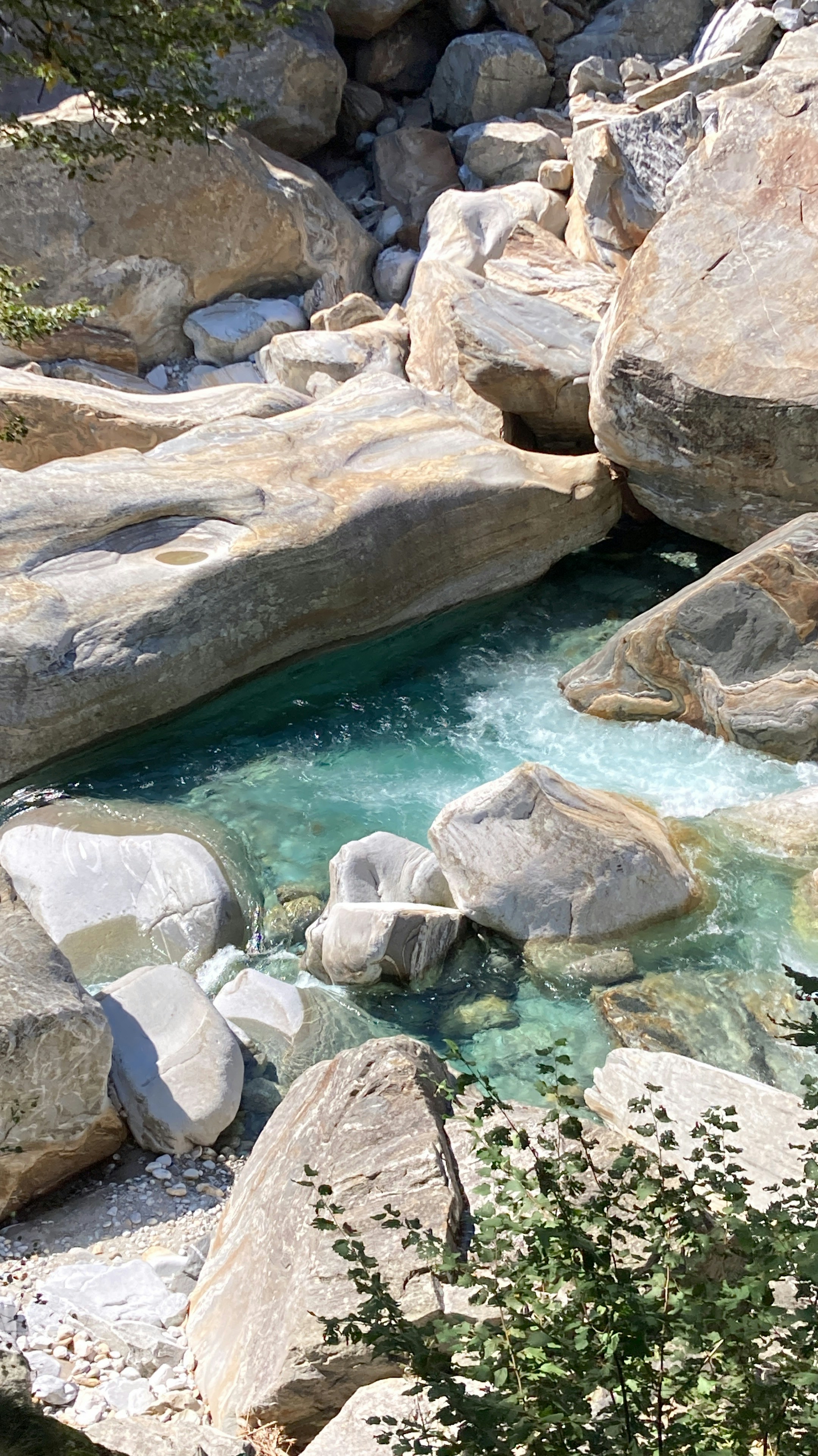A small pool of water surrounded by rocks photo – Free Rock Image on ...