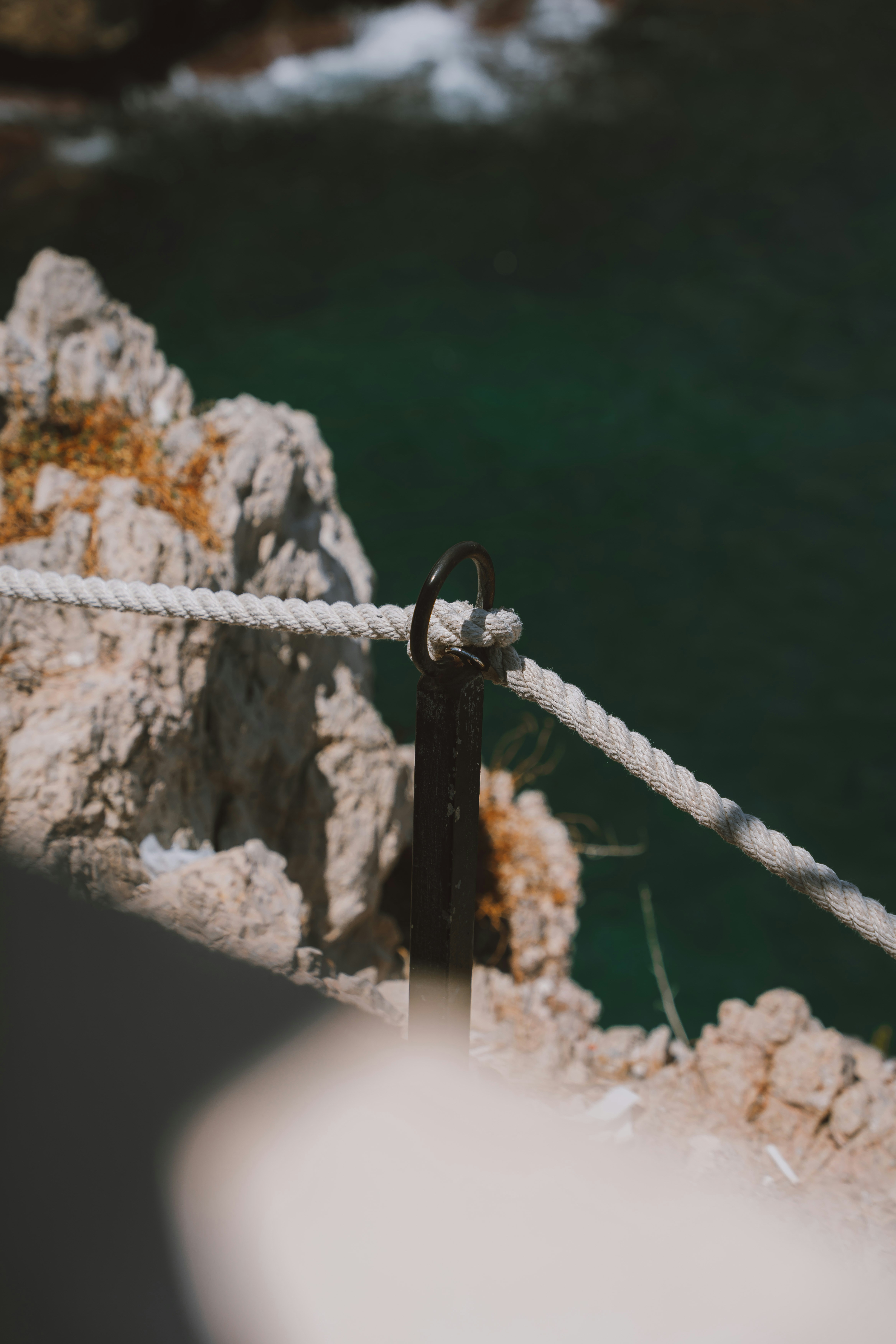 A close up of a rope with a body of water in the background photo ...