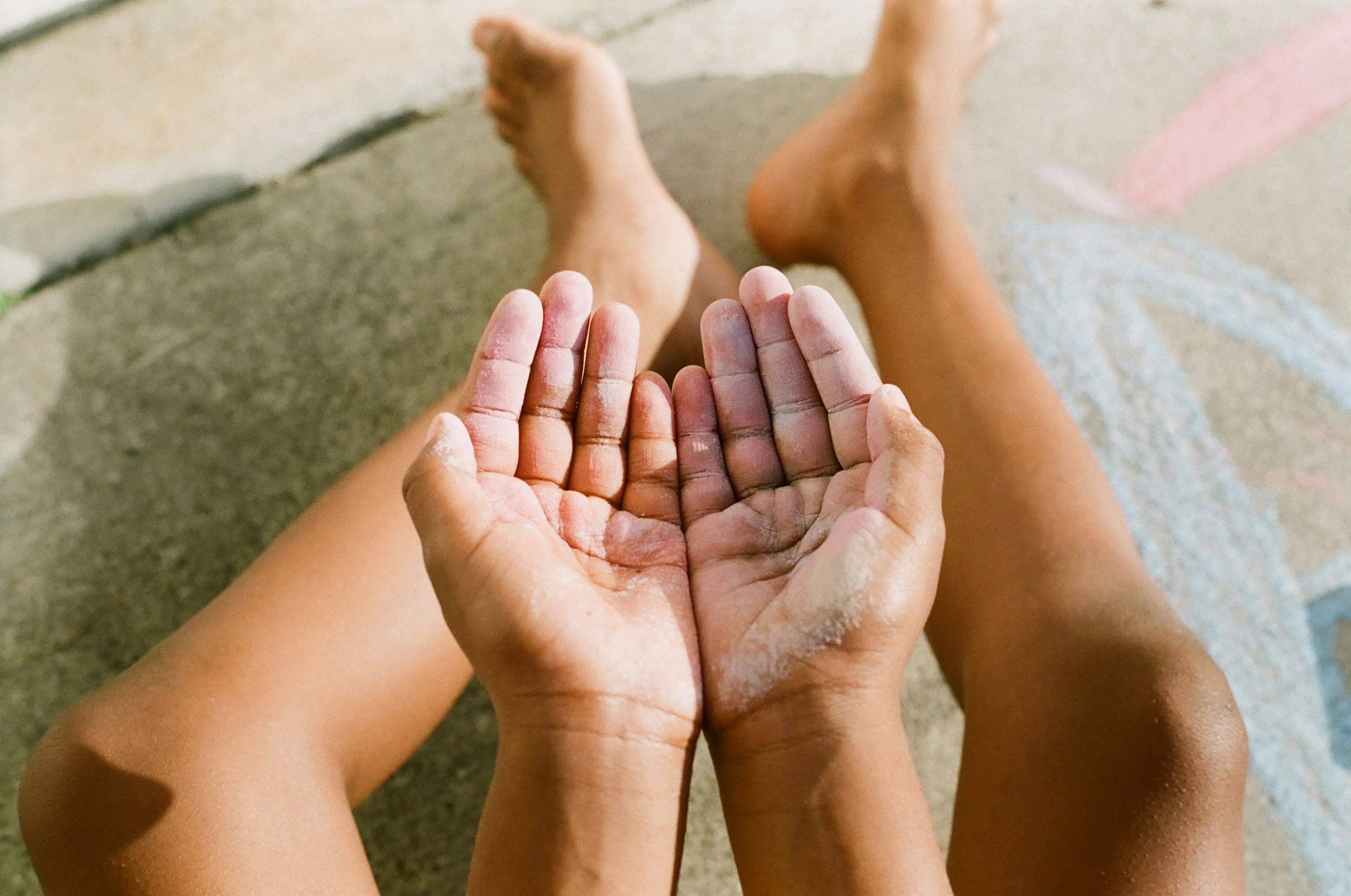 A person laying on the ground holding their hands together photo – Free ...
