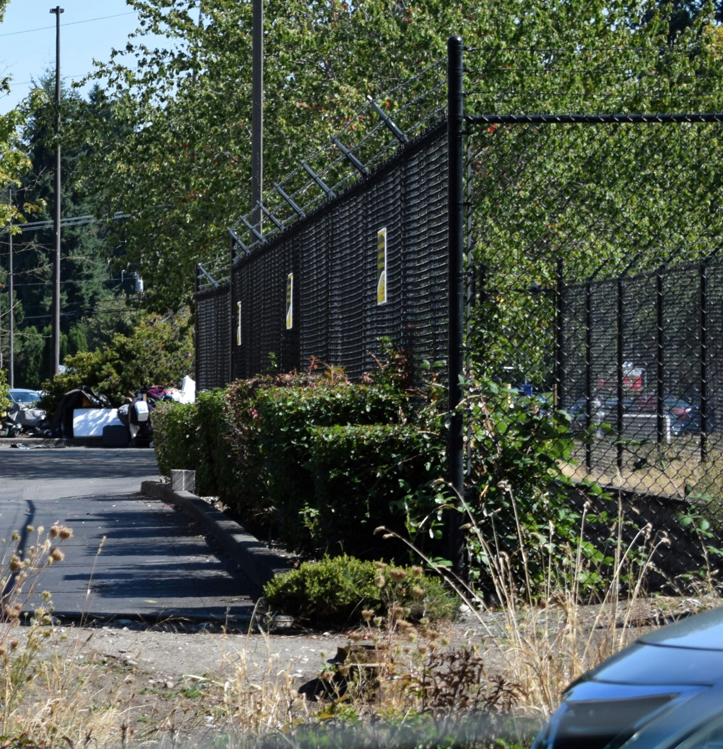 A fenced in parking lot next to a parking lot photo – Free Seattle ...
