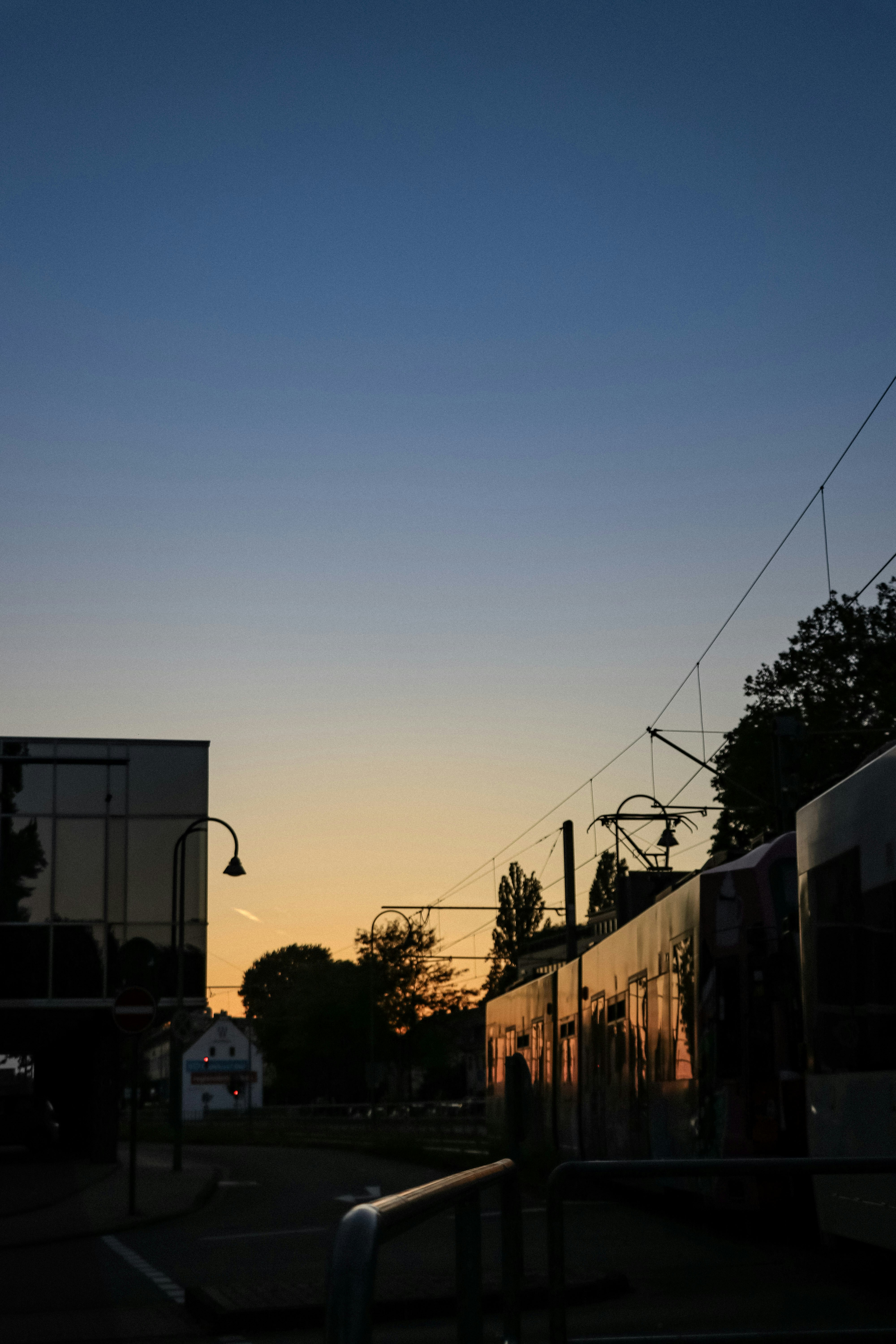 Sunset on Rails: Trams, Wires, and a Quiet Dusk Cityscape