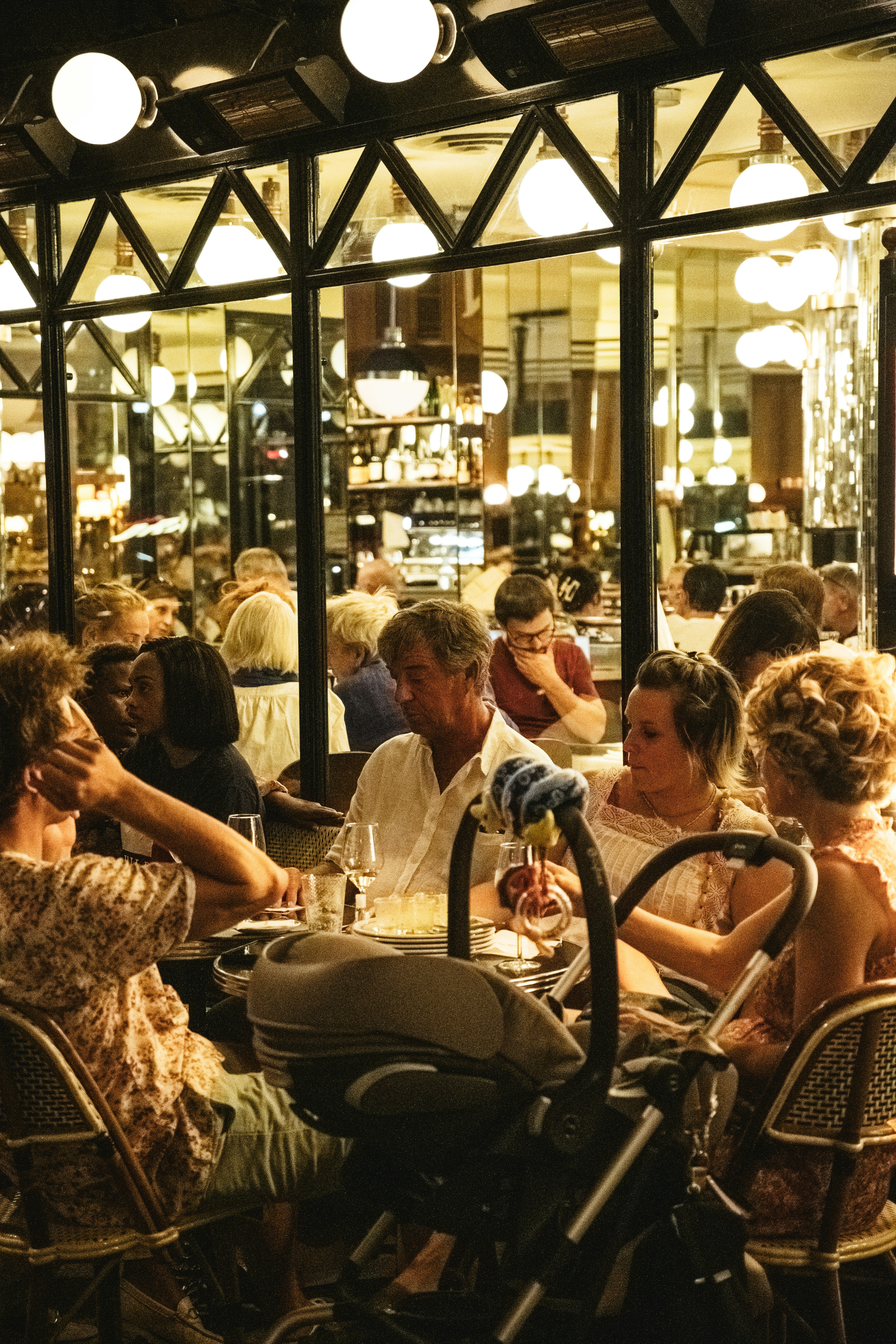 Amber Lanterns, Converging Voices: A Crowded Café Portrait