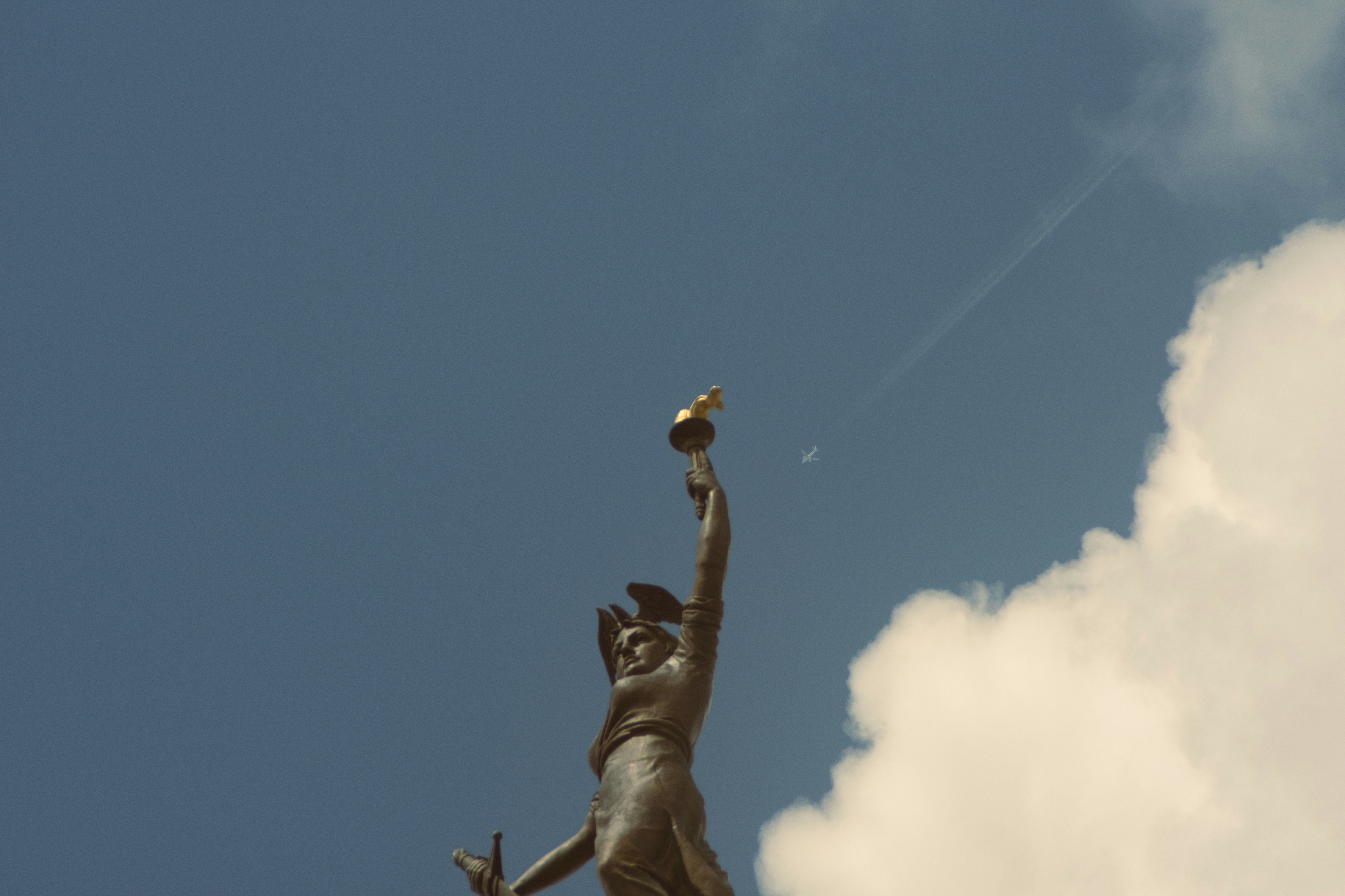 A statue of a woman reaching up into the sky photo – Free City Image on ...