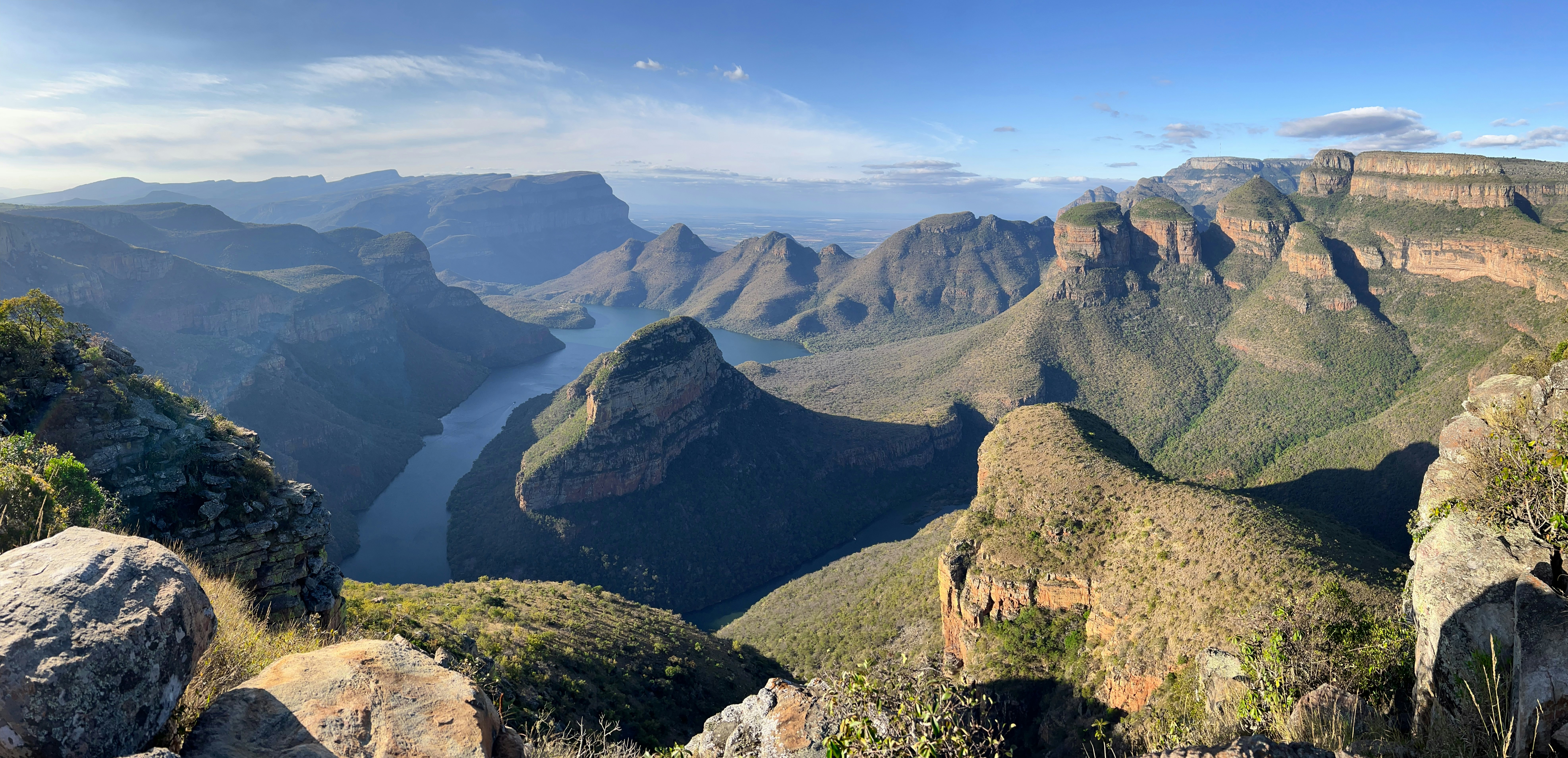Rifted Horizon: A River Winding Through Canyon Cliffs