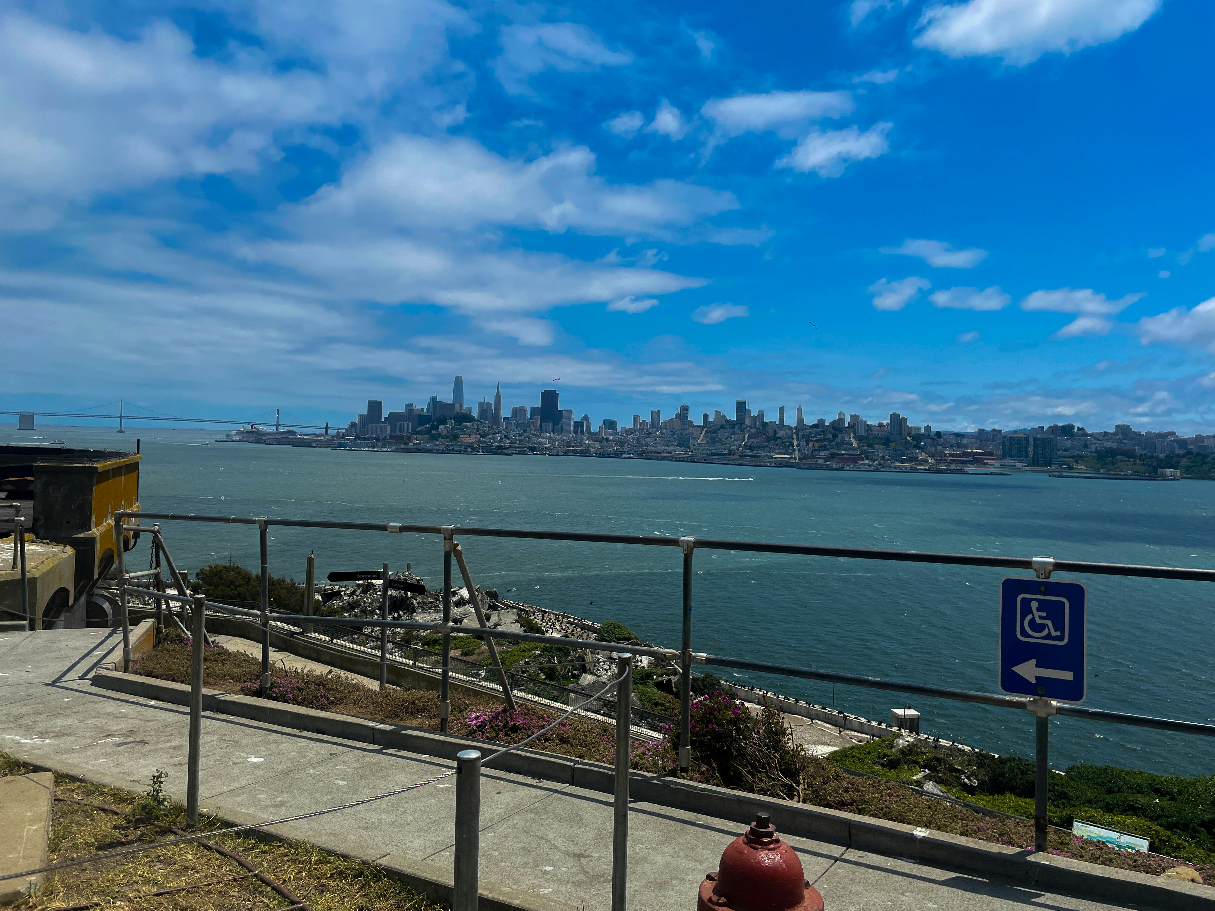 Blue-Horizon Promenade: Rails Framing a Distant Skyline