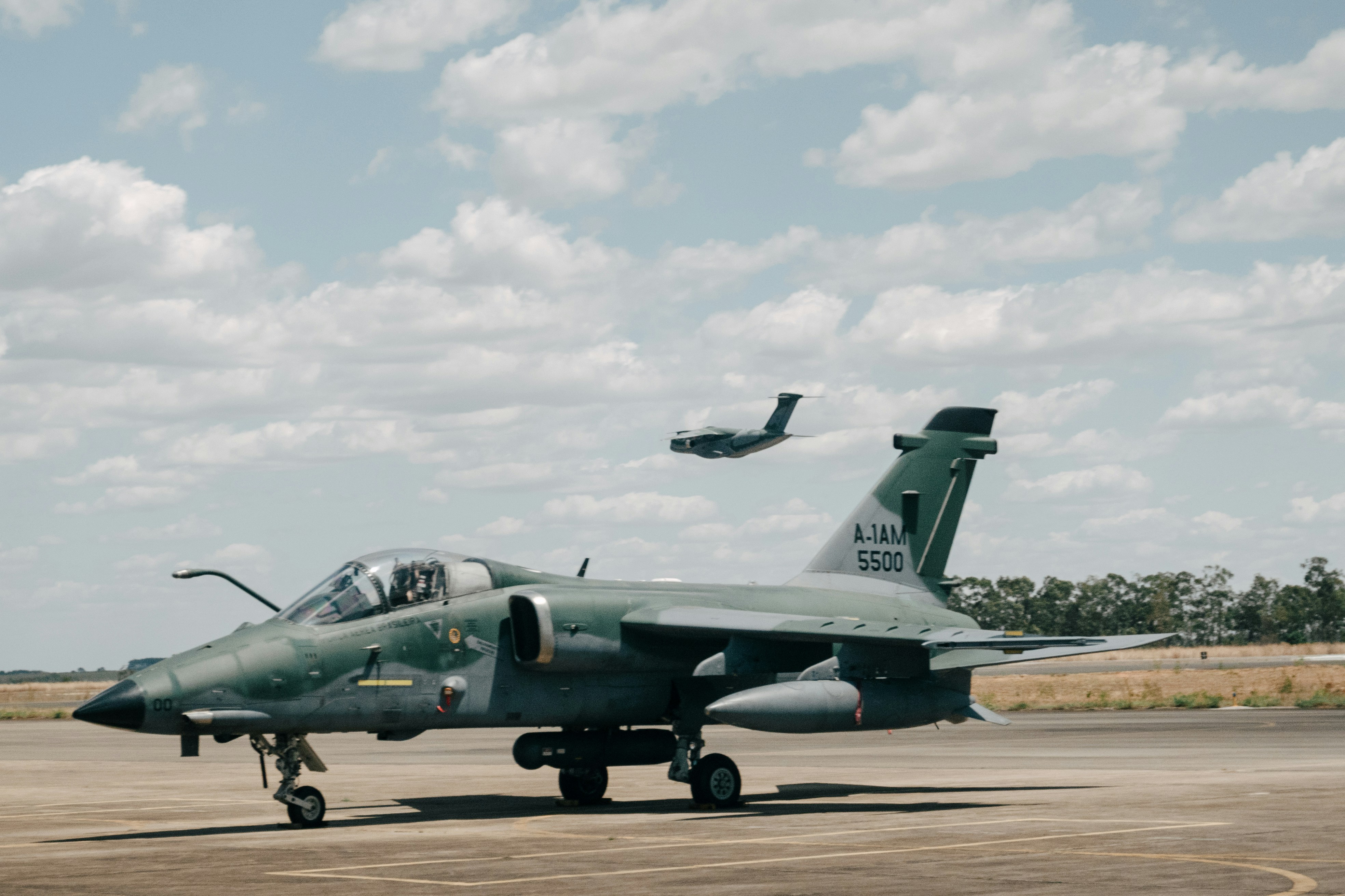 A fighter jet sitting on top of an airport tarmac photo – Free Airplane ...