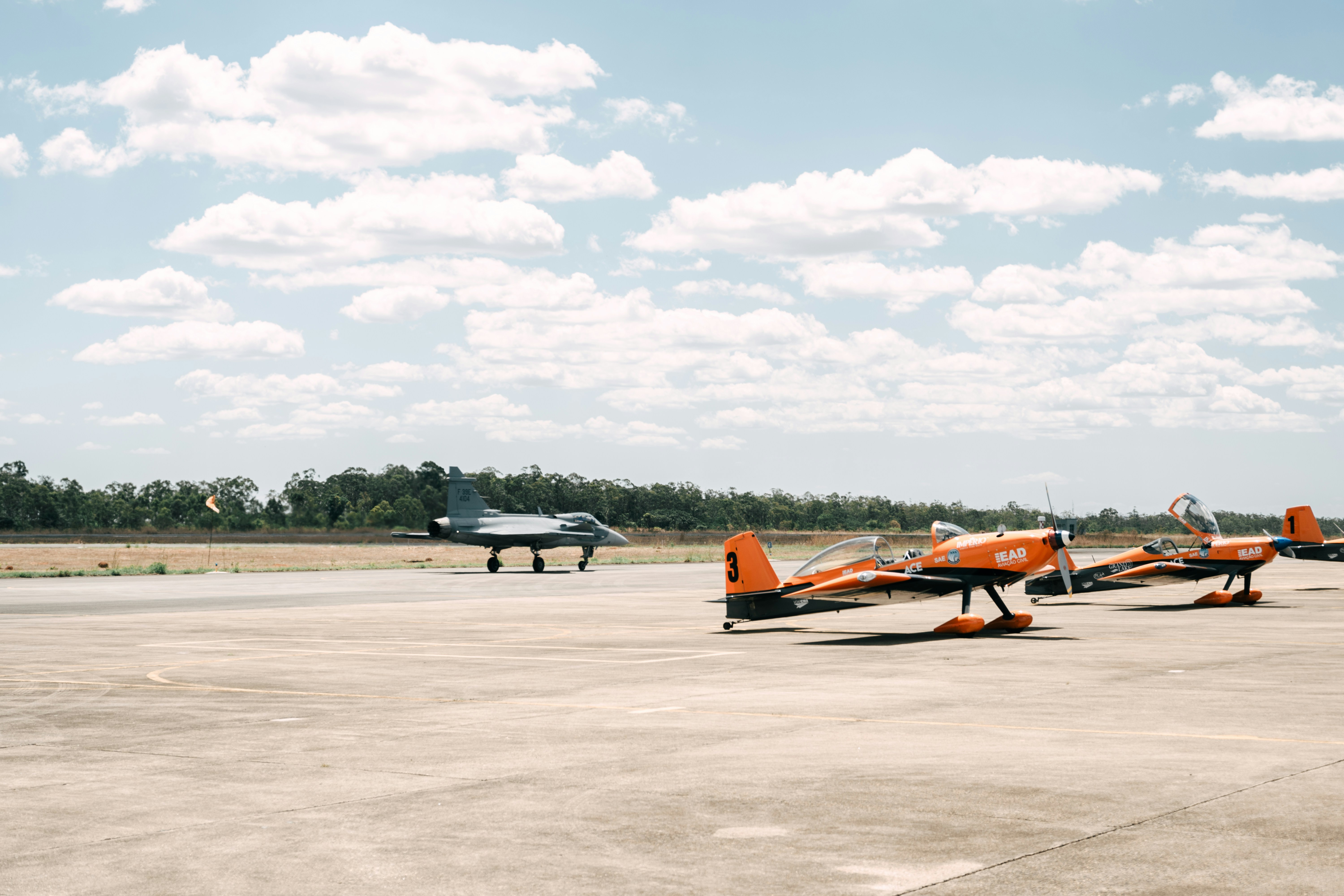 Orange Jet Training Row on Sunlit Tarmac