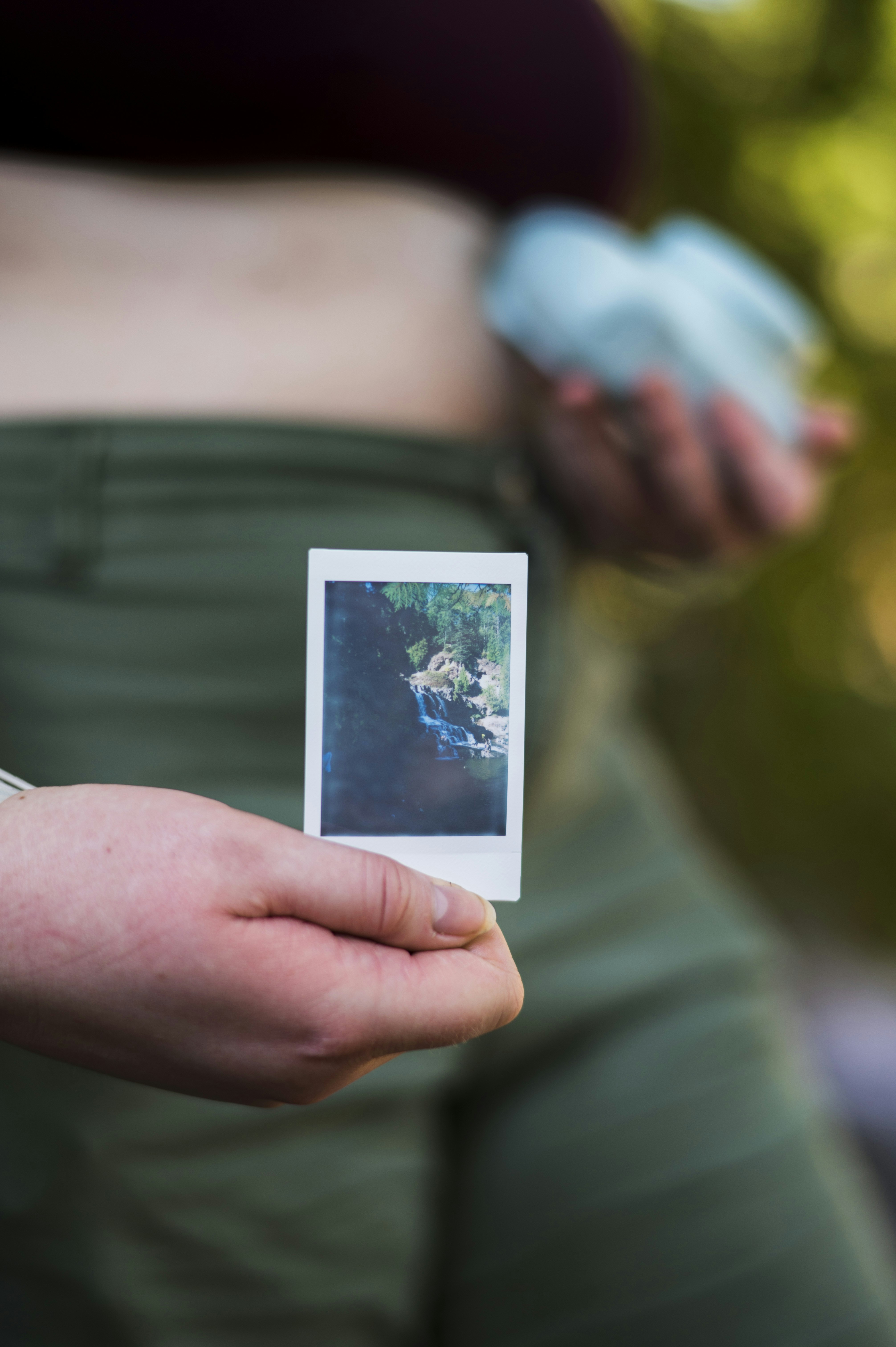 a person holding a polaroid picture in their hand