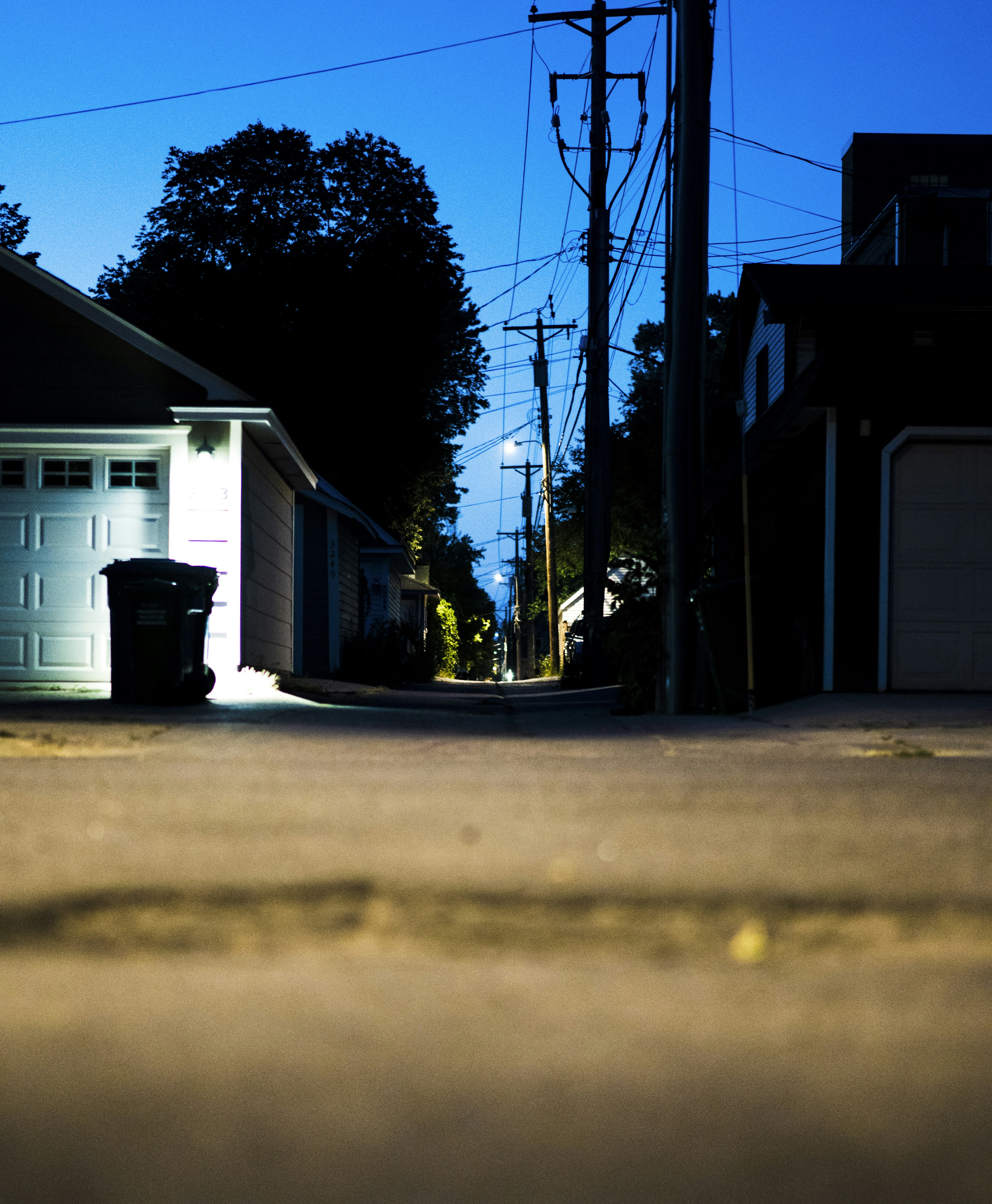 Laneways at Dusk: A Quiet Street Bordered by Shadows and Neon