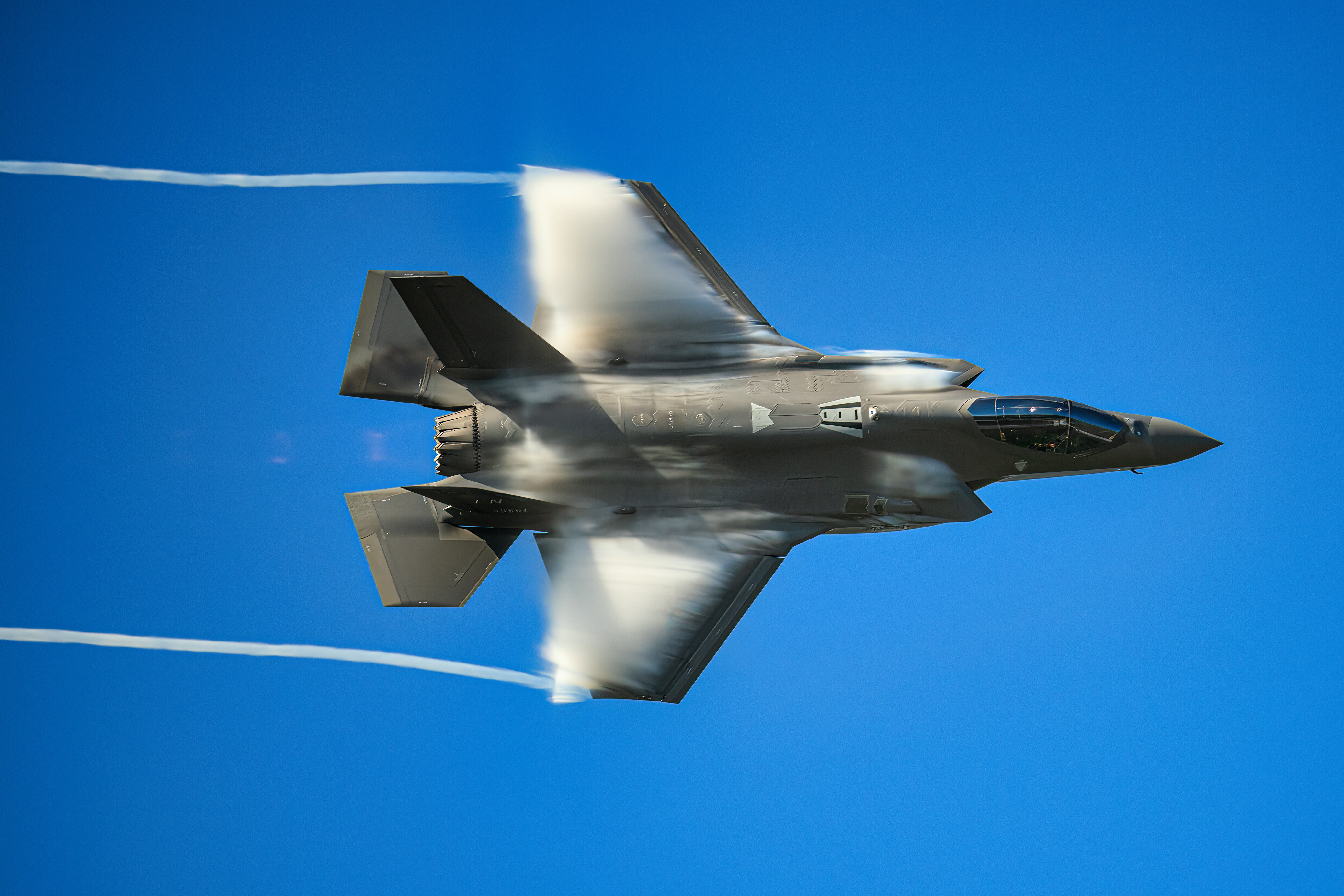 A fighter jet flying through a blue sky photo – Free Kleine-brogel ...