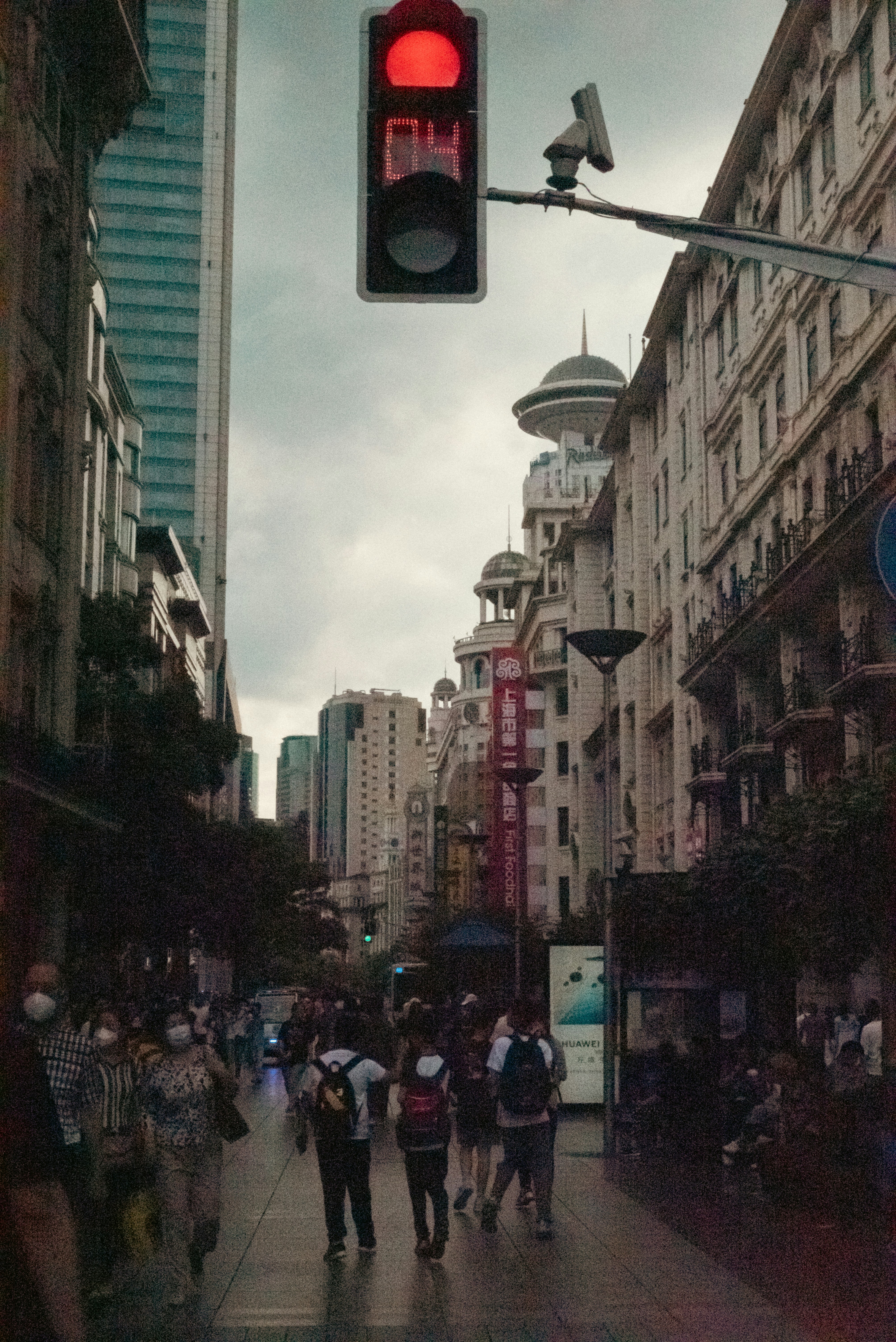 Red Signal, City Pulse: Pedestrian Crosswalk Beneath Towering Facades