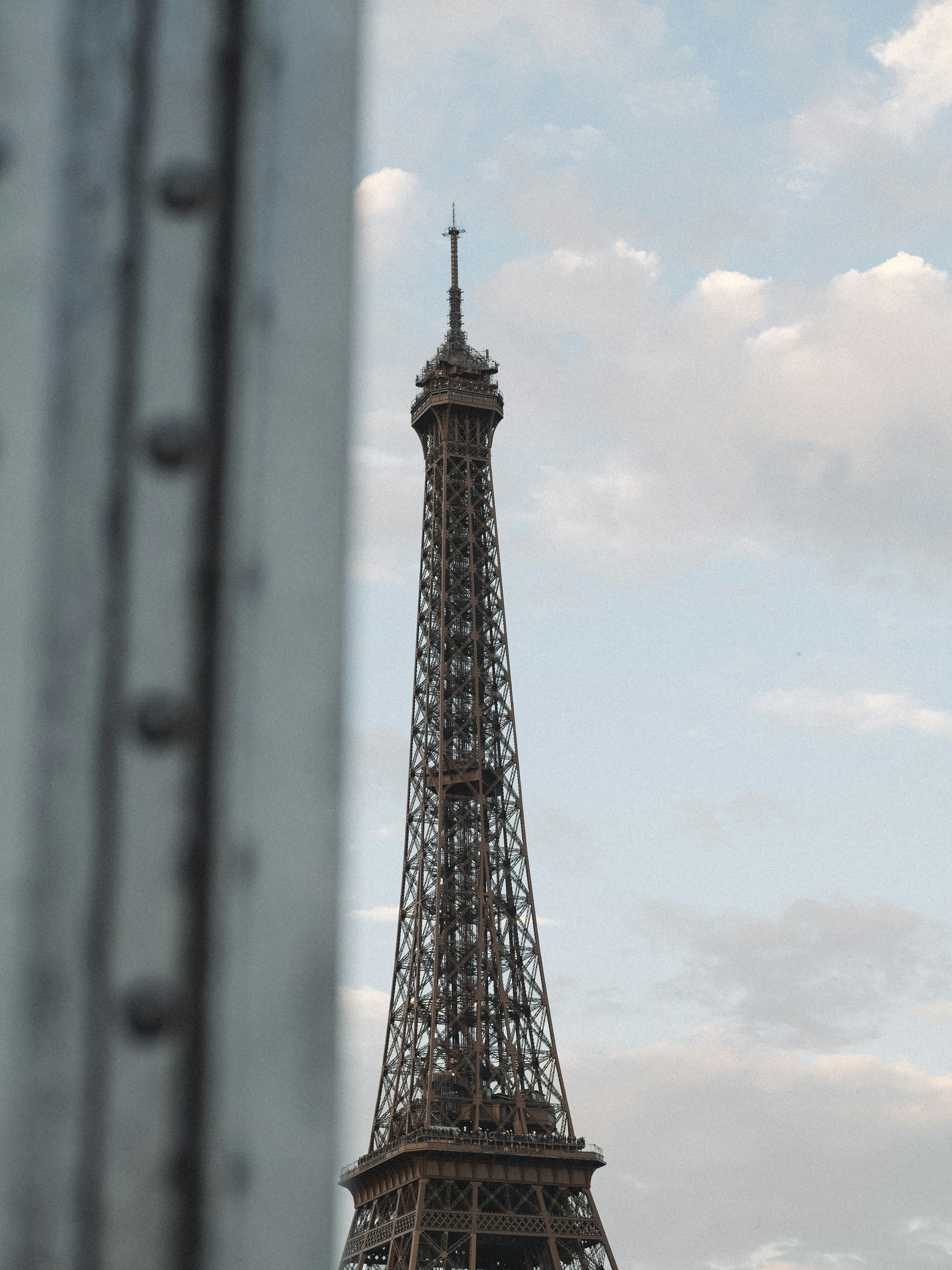 Eiffel Tower Emerges Through a Narrow Steel Frame