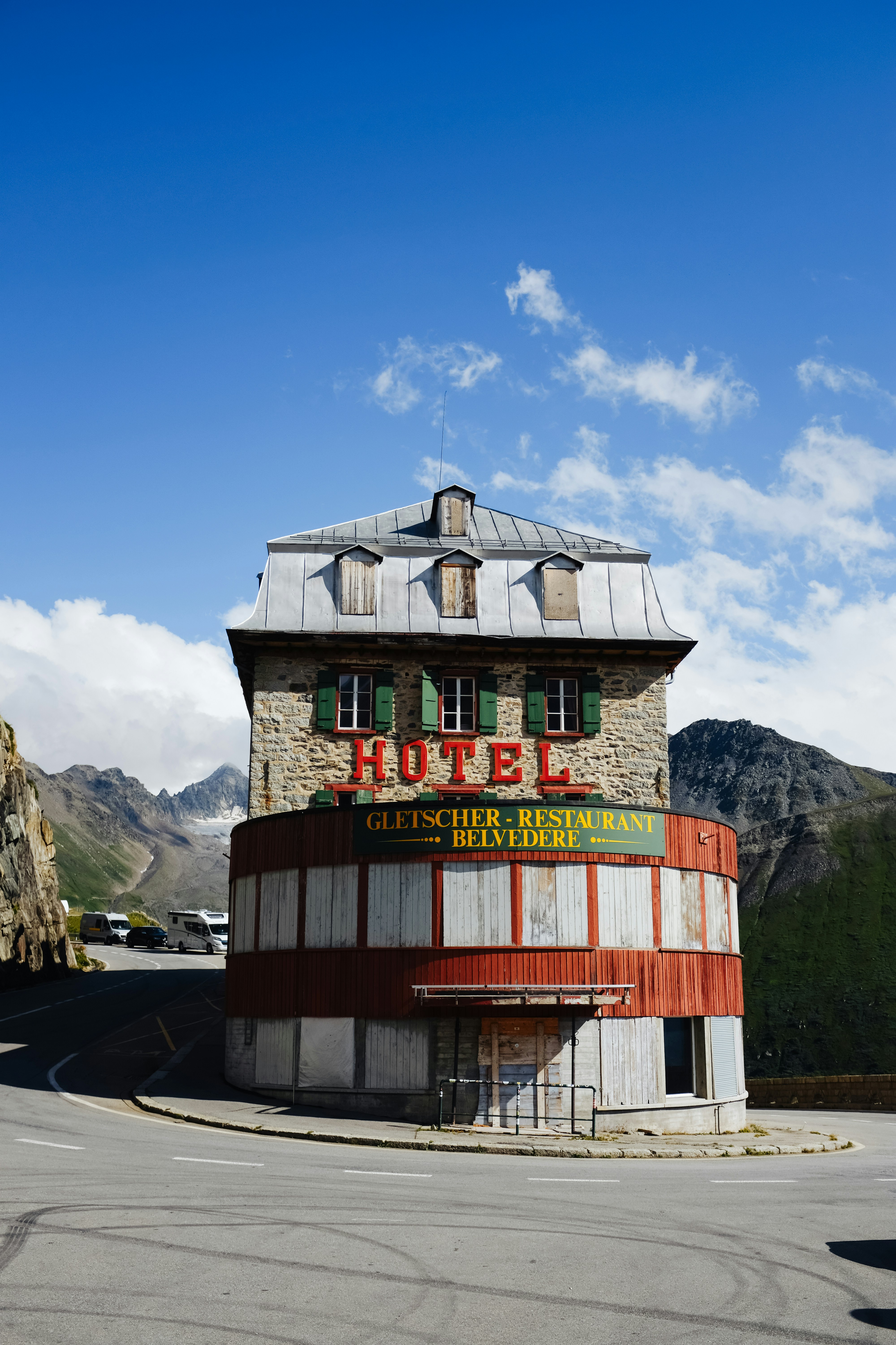 Cylindrical Alpine Hotel on a Hairpin Curve Beneath a Clear Sky