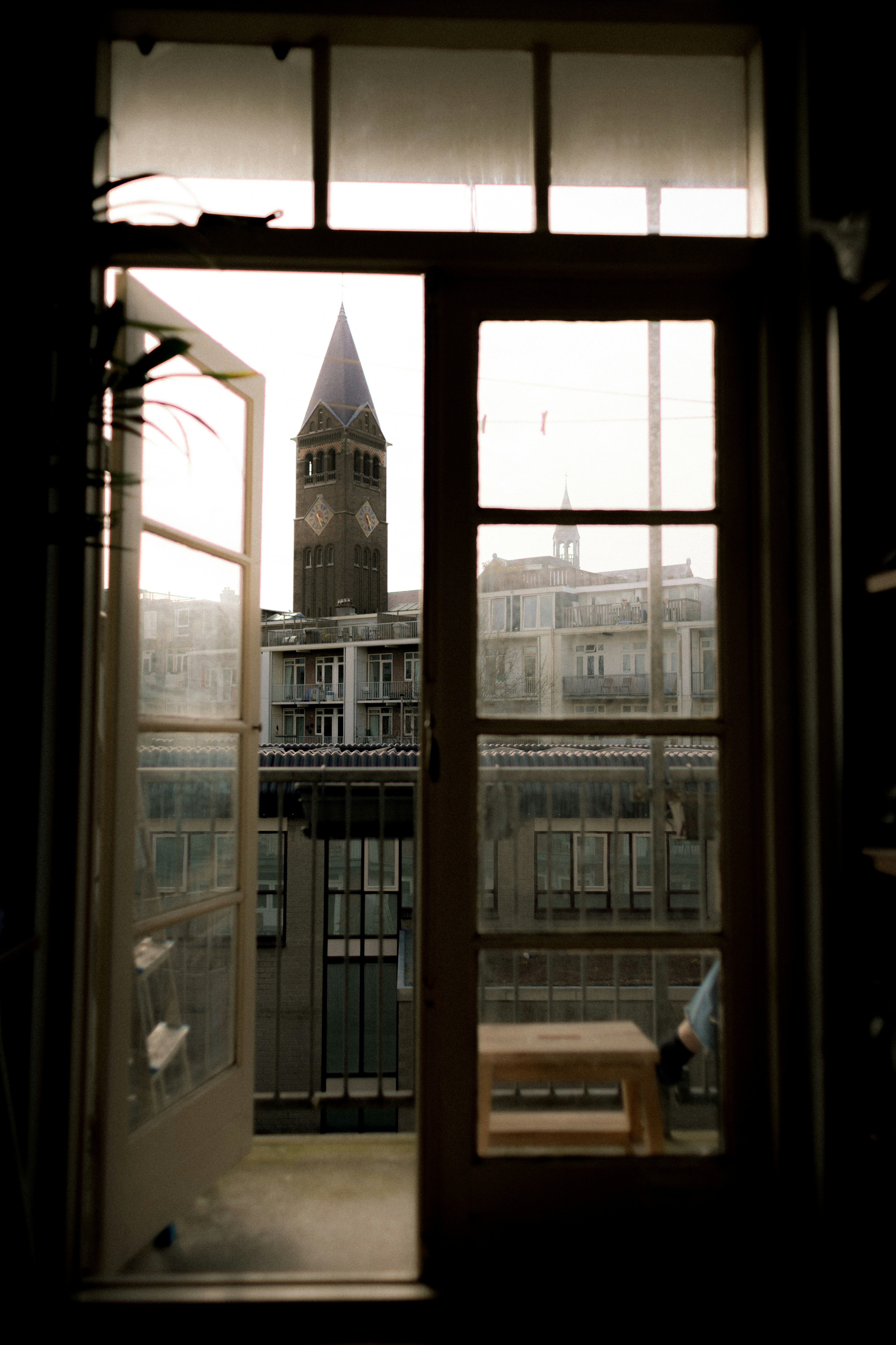 A view of a clock tower through a window photo – Free Design Image on ...