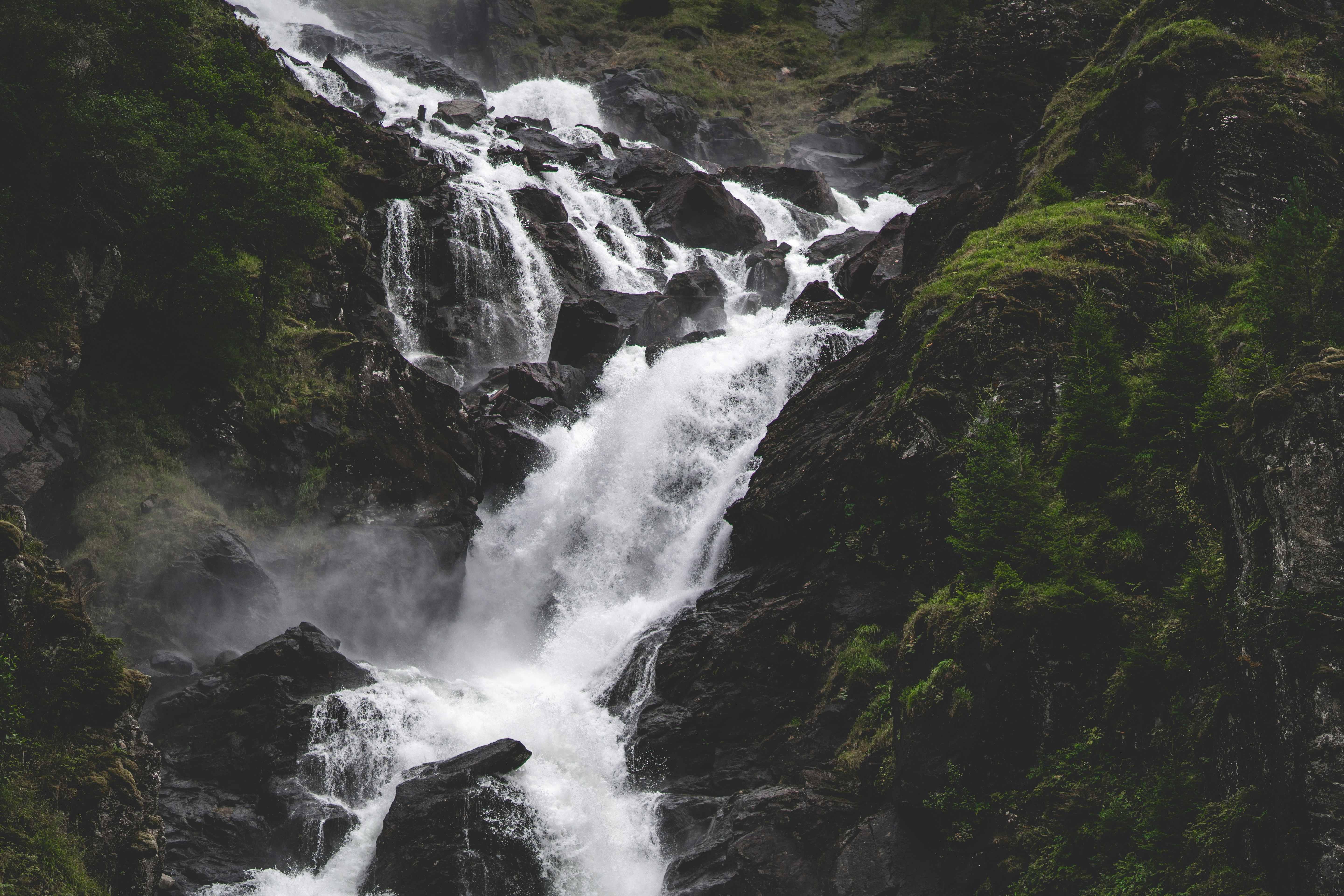 A waterfall with water cascading down the side of it photo – Free ...