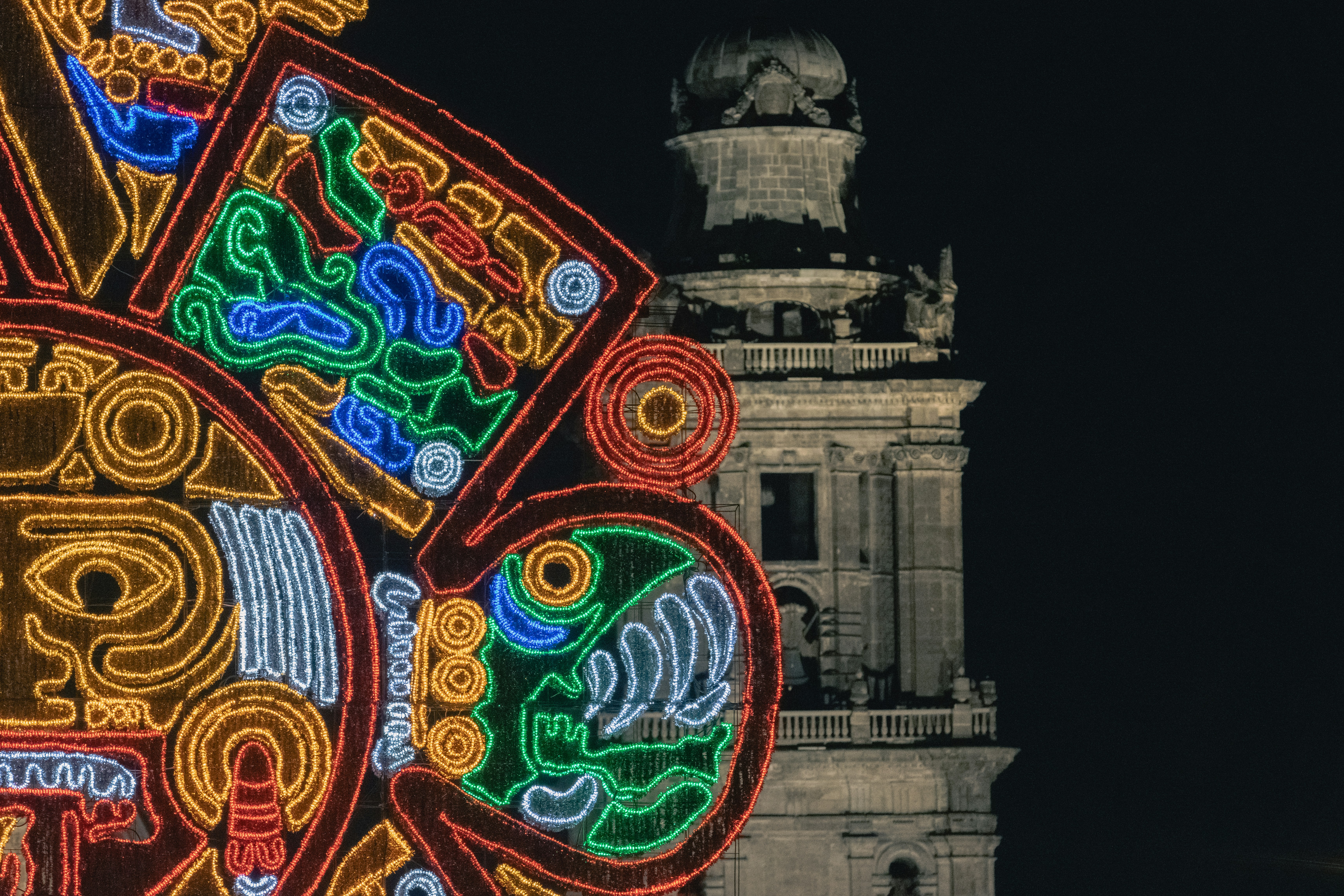 Neon Dragon Wheel Framing a Silent Tower at Night
