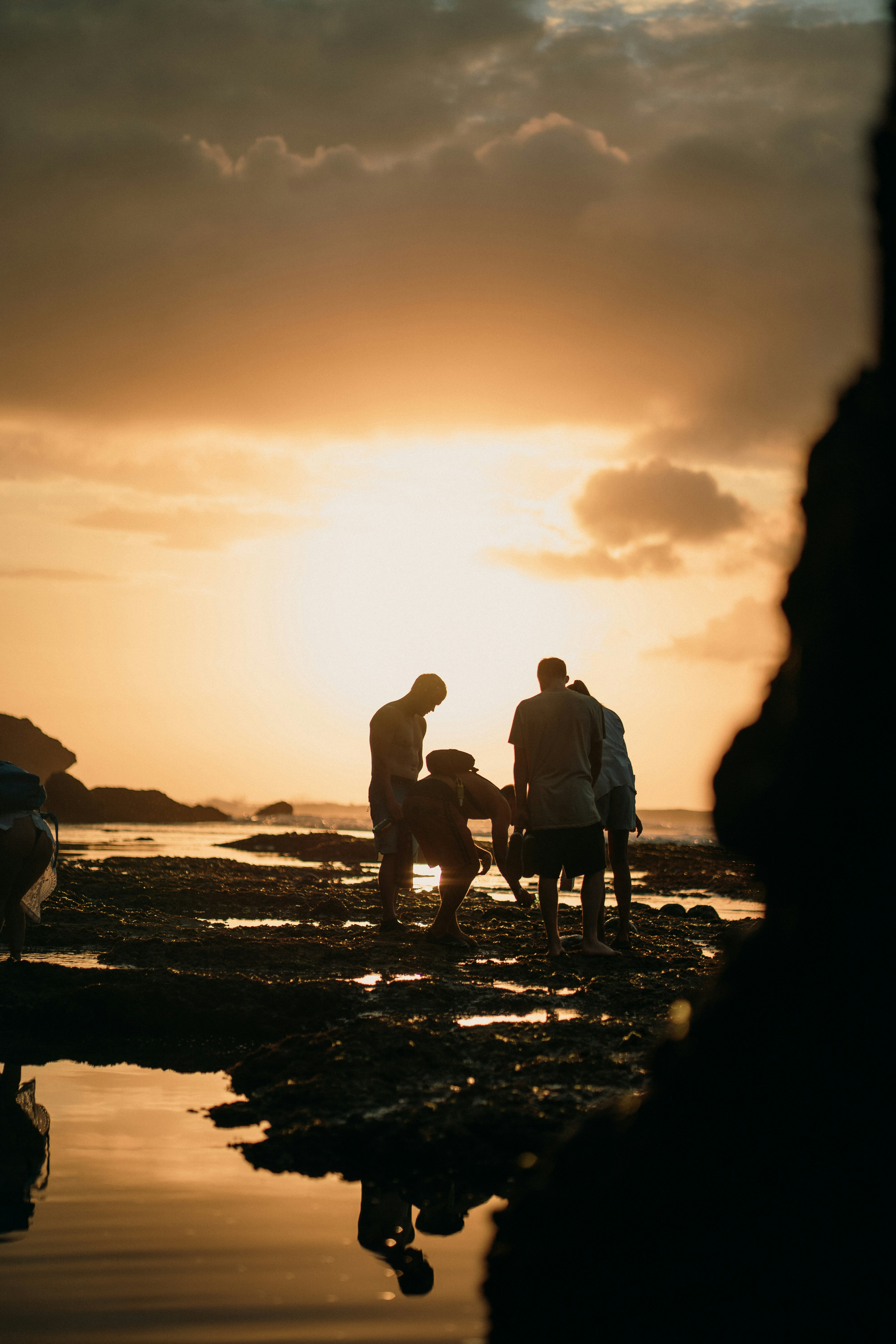Five Silhouettes at the Tide's Edge During Golden Hour
